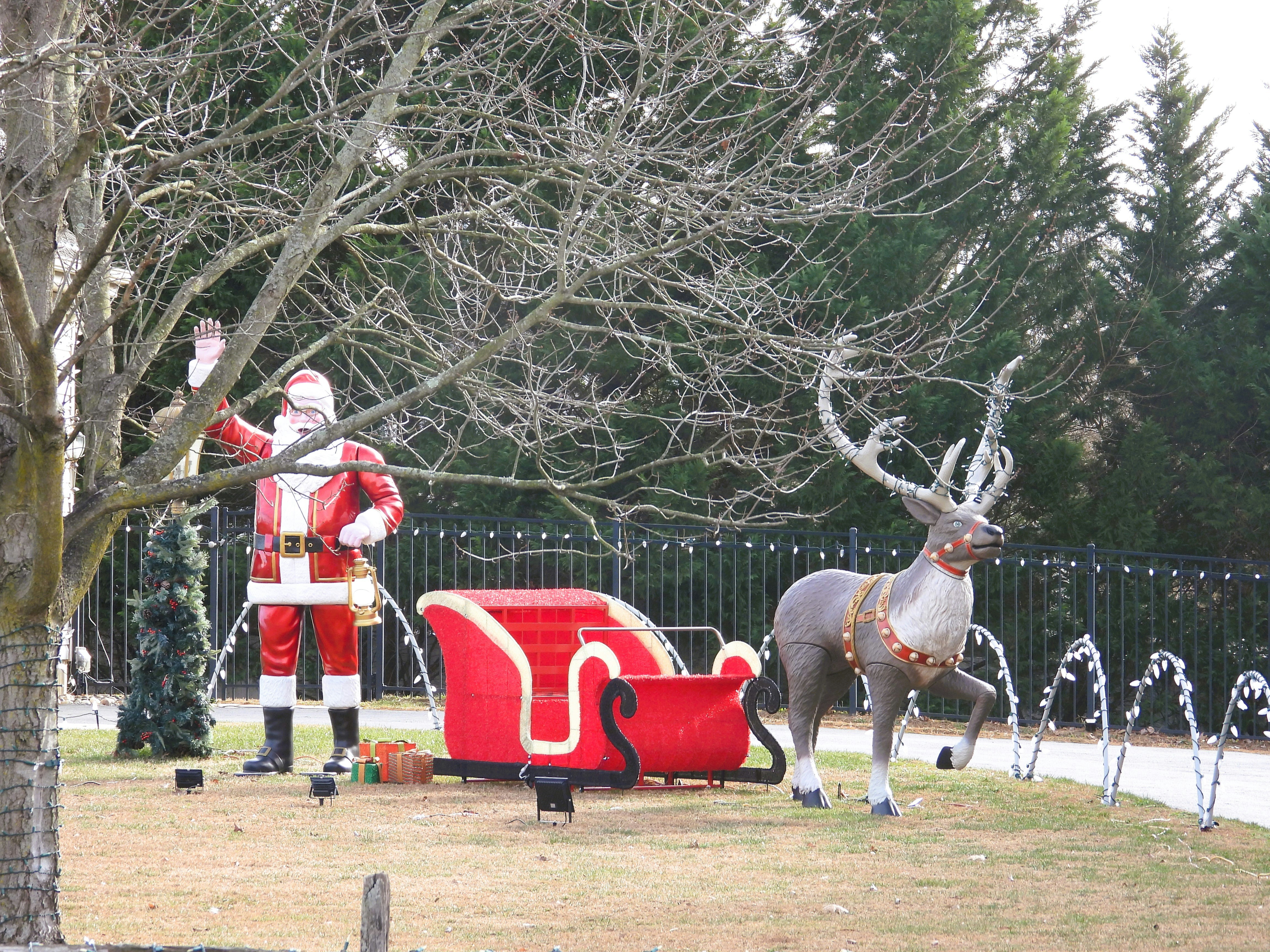 A Santa Claus with sled and reindeer.