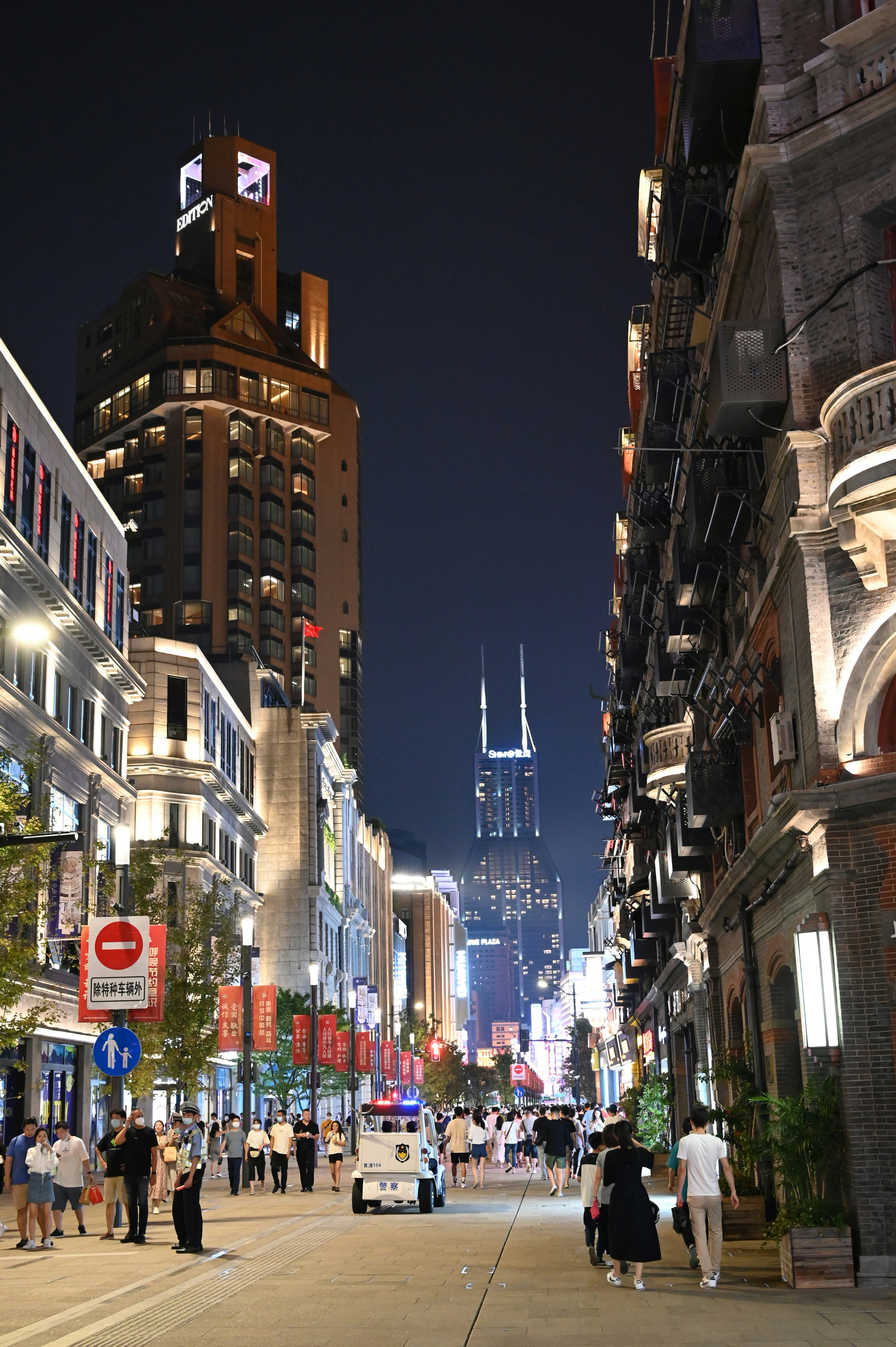 Lantern-Glow Avenue: Night Walk Toward the Twin Spires