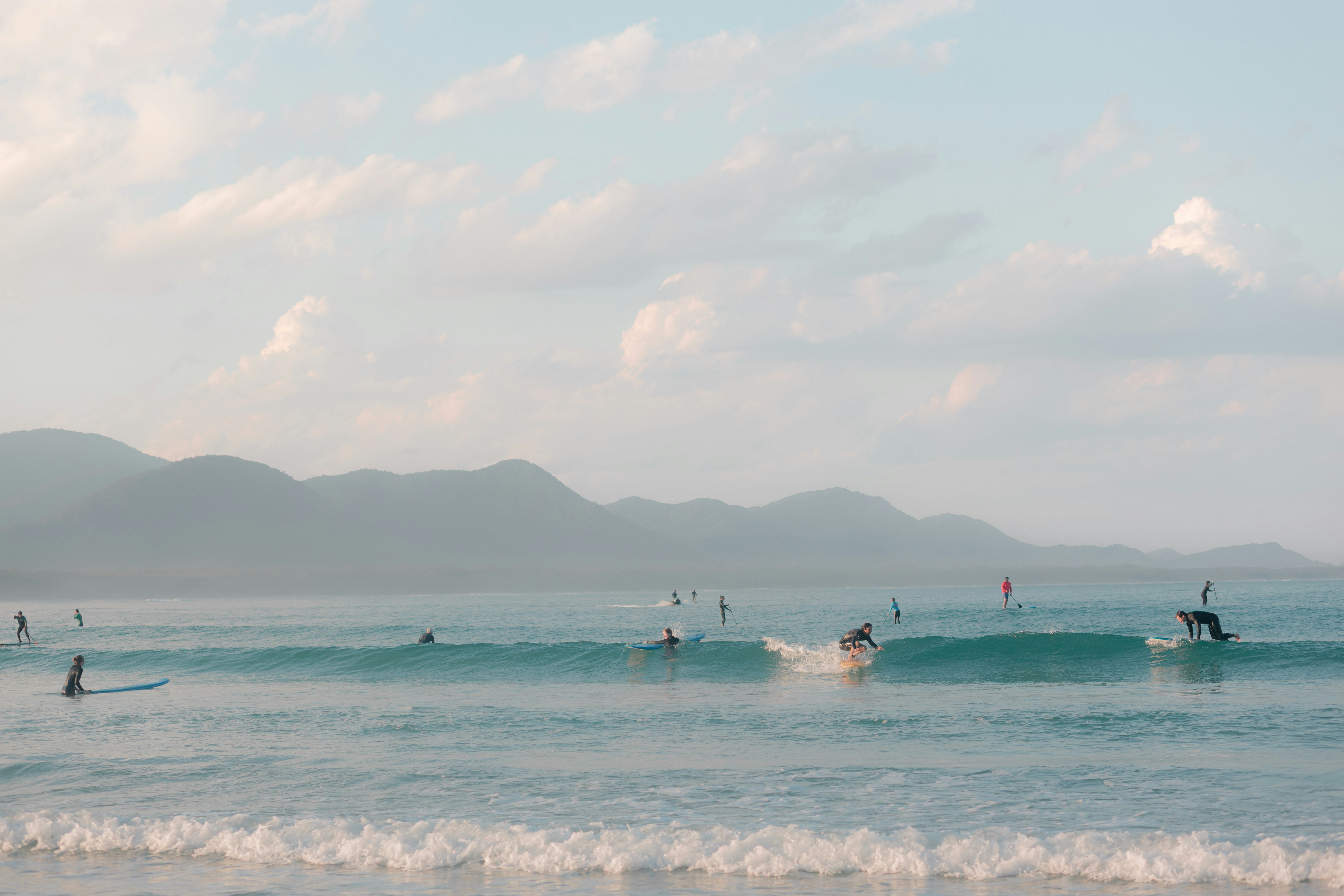 Morning Swell: Surfers Ride a Gentle Pacific Break