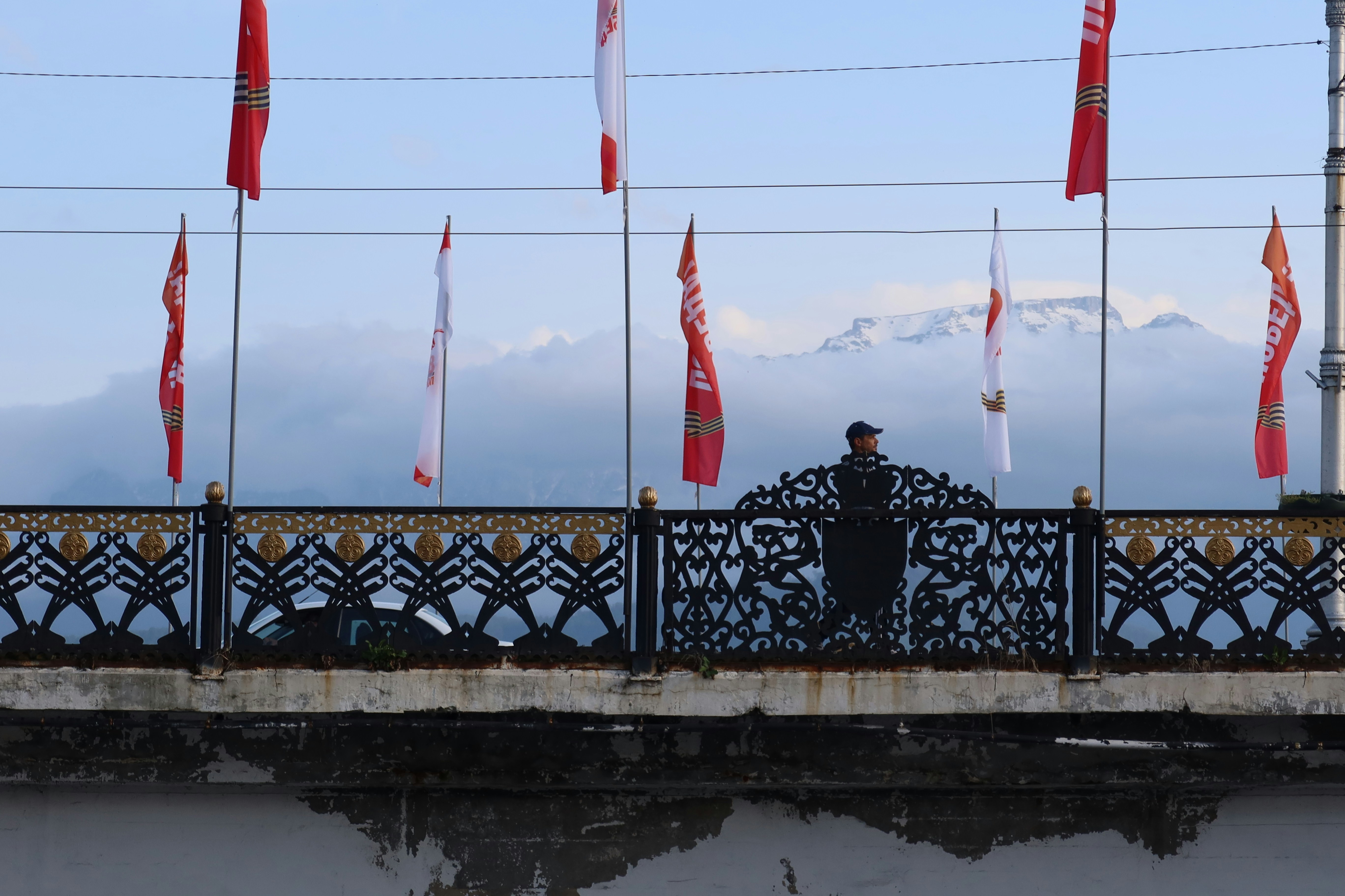 Guard on a Decorative Balcony Over a Misty Mountain Line