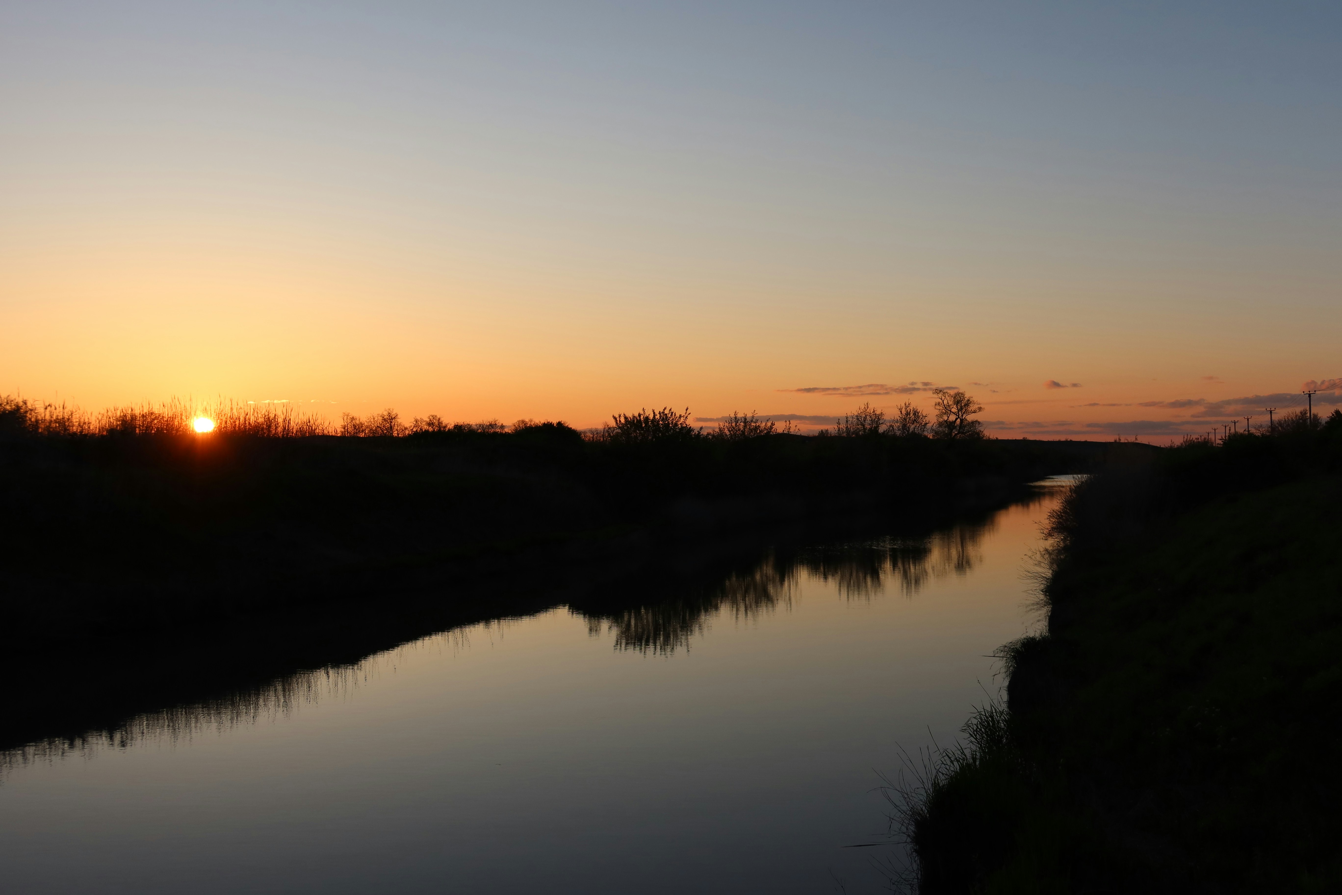 Sunset River Silhouette Over Quiet Bend