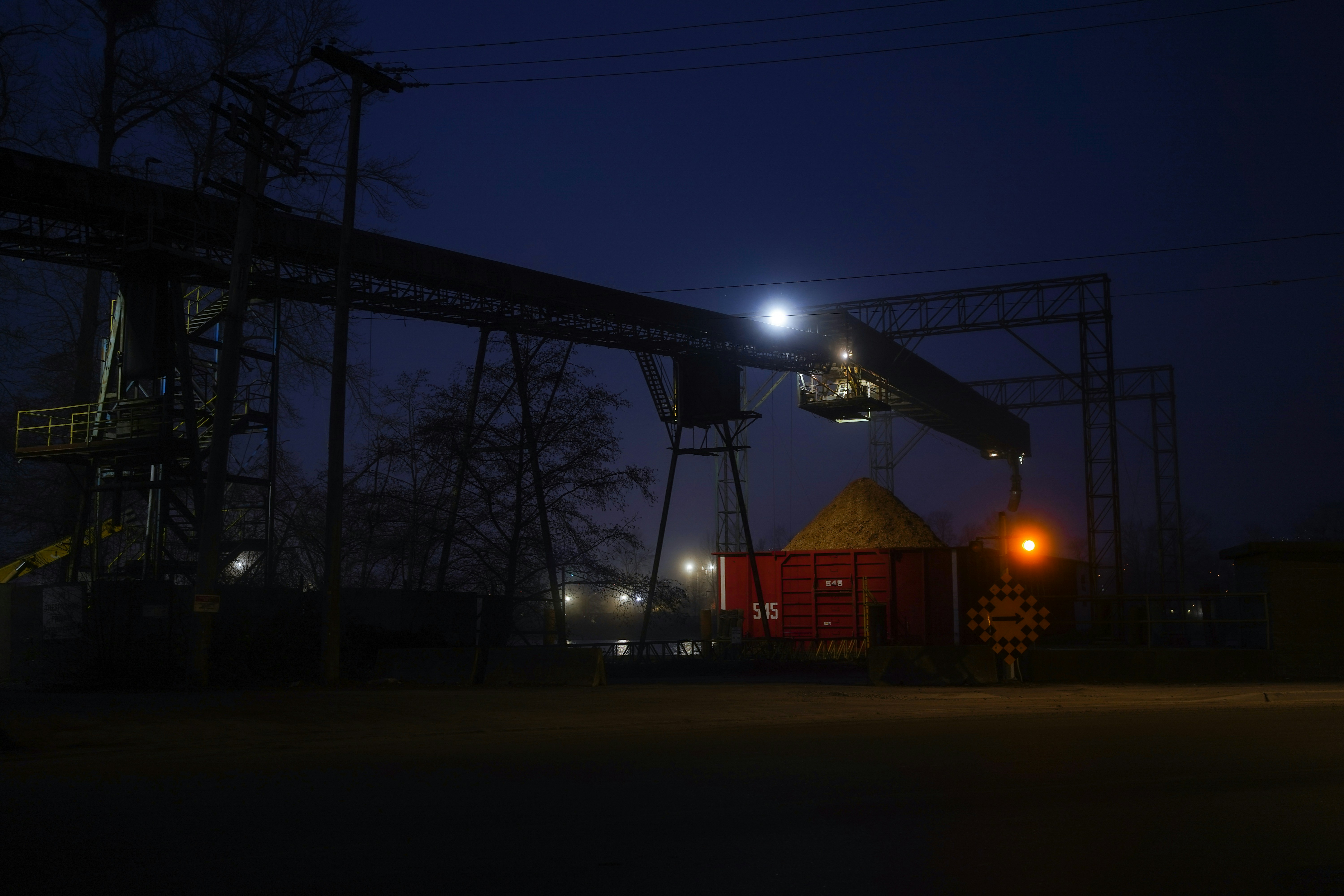 Night Crane at the Coal Yard: A Quiet Conveyor of Steel and Smoke