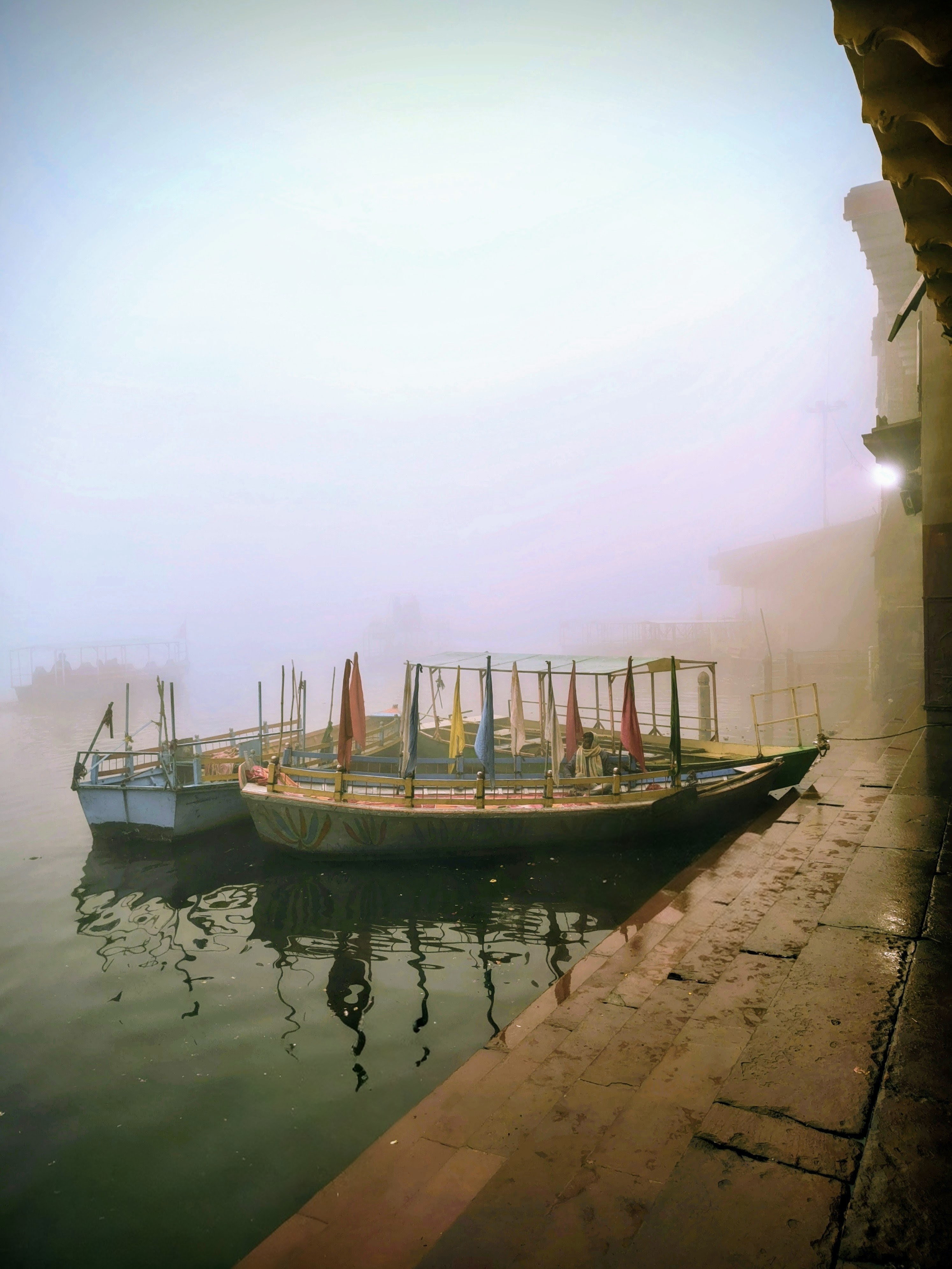 Misty Harbor: Boats Rest at Distant Dawn