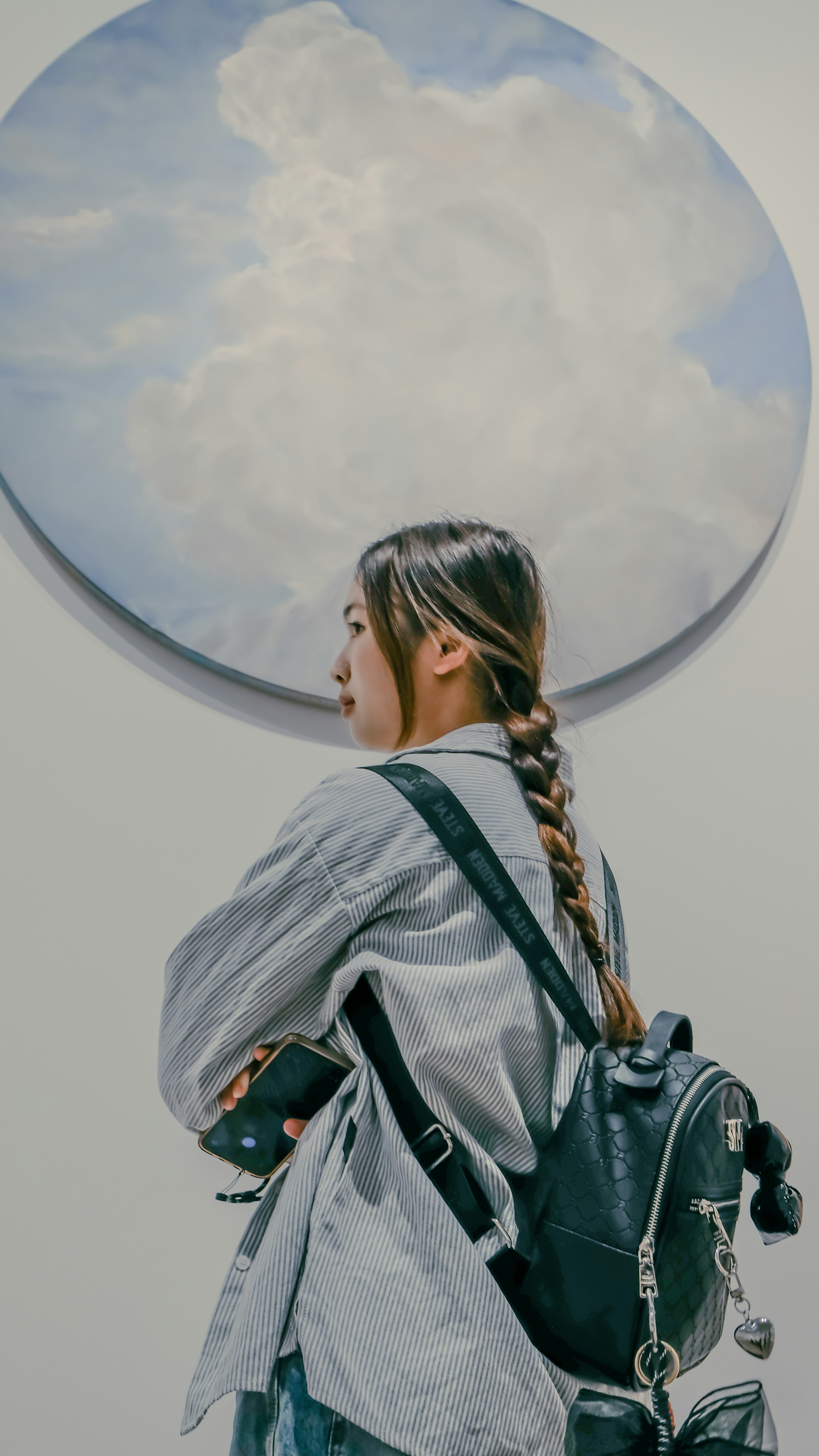 Cloud Circle Portrait: A Quiet Moment with a Braided Traveler