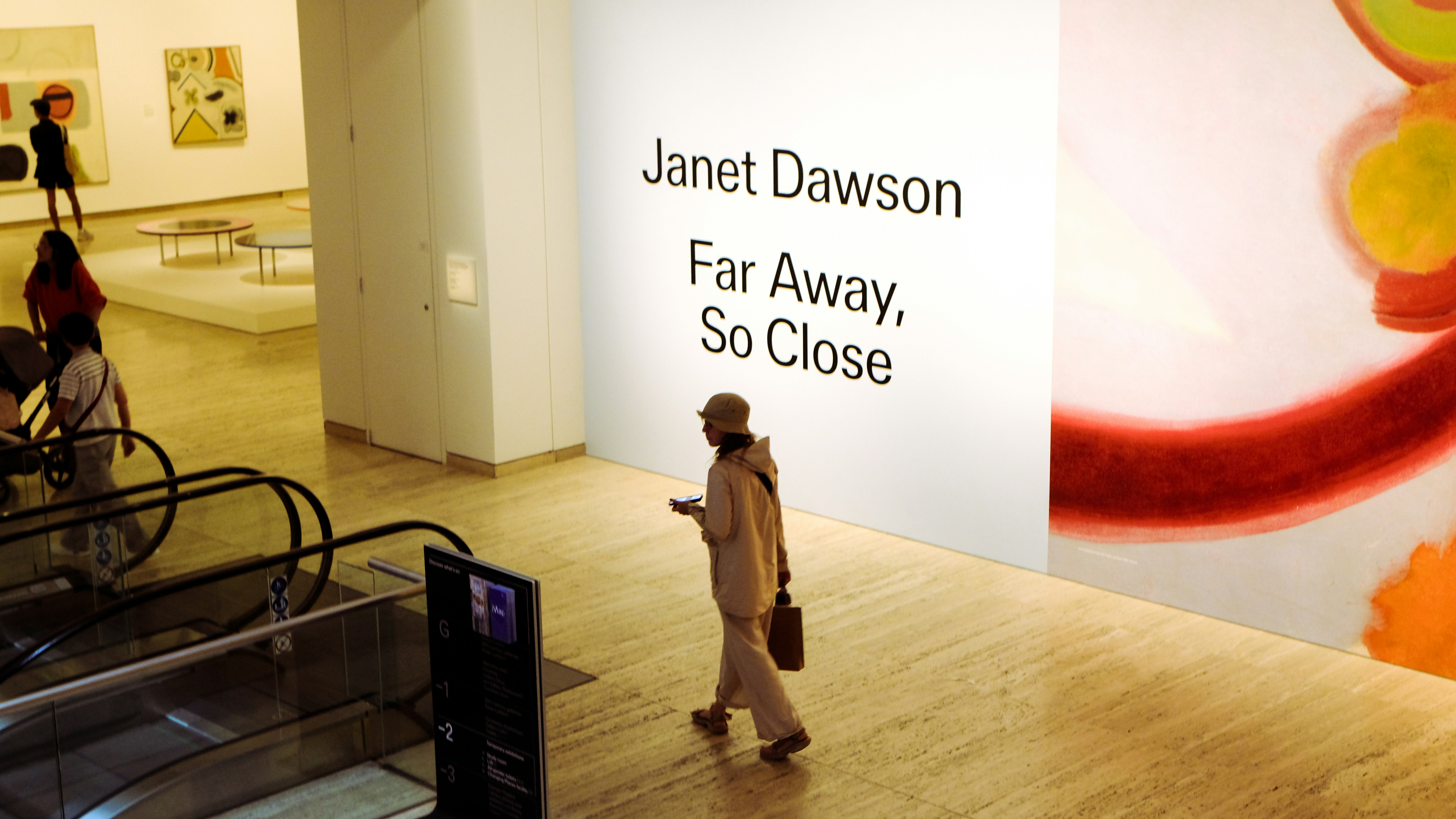 People in an art gallery with exhibit title