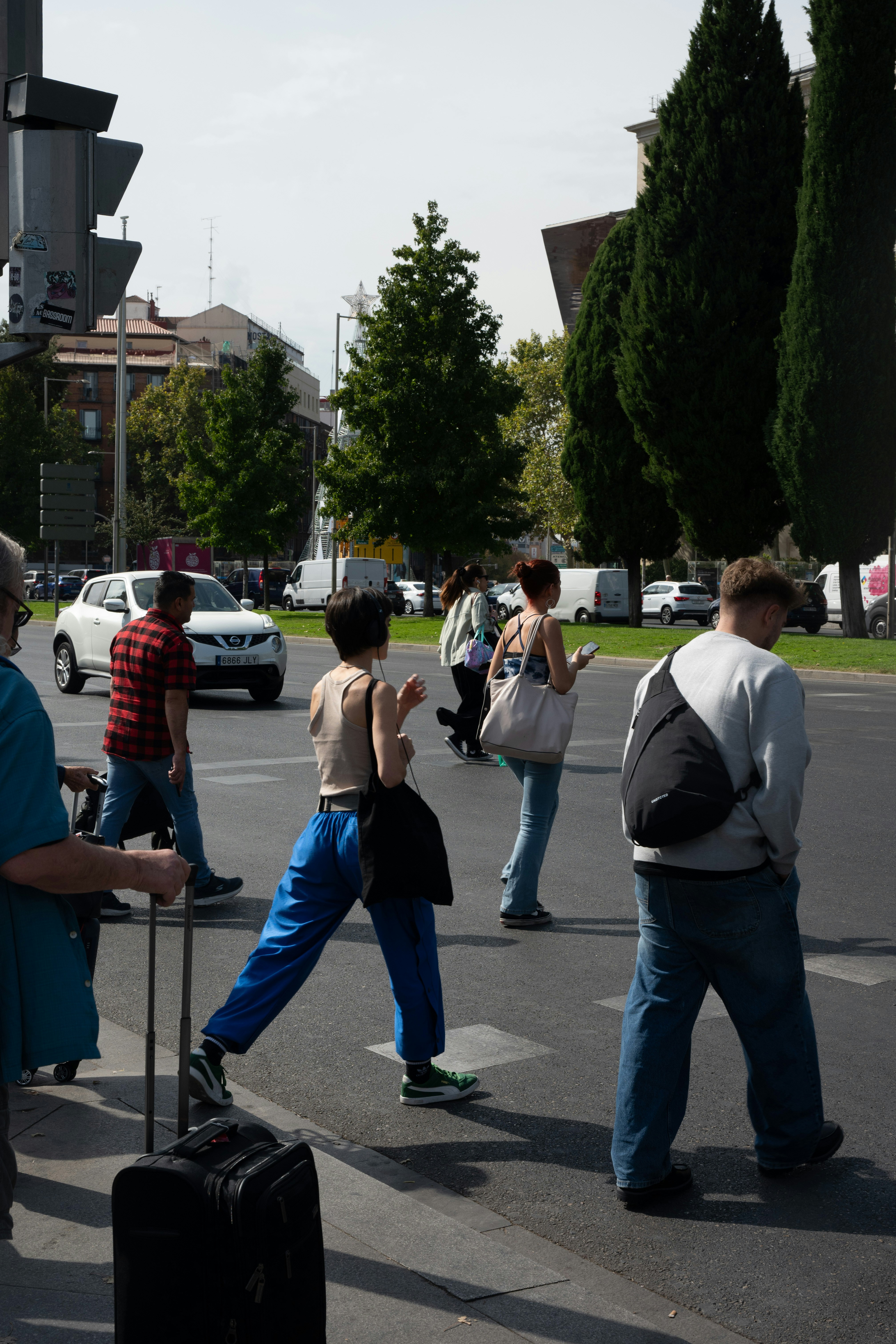 Crosswalk Moment: People Crossing Amid Urban Pace