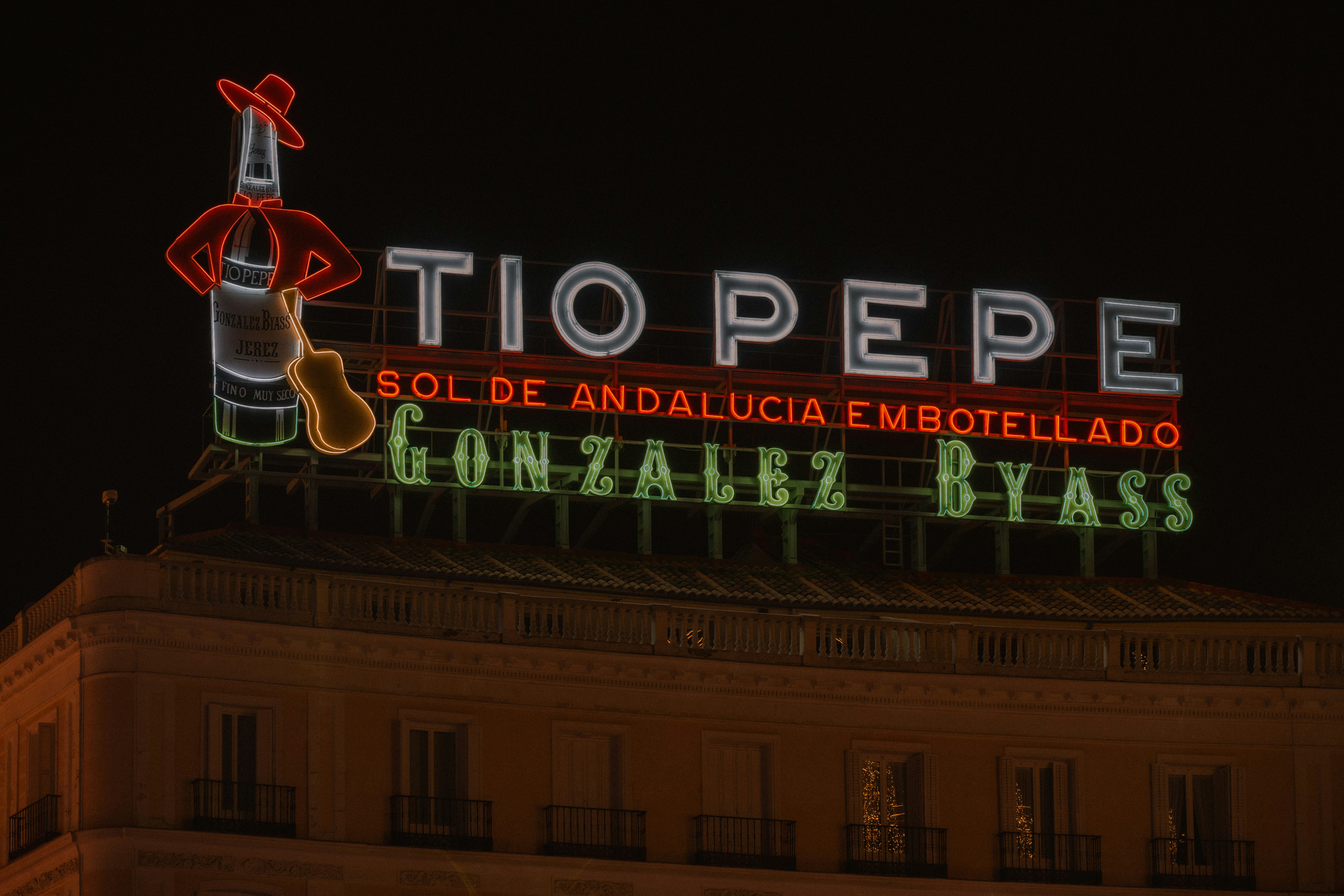 Neon Cowboy Sign Over Madrid Rooftops