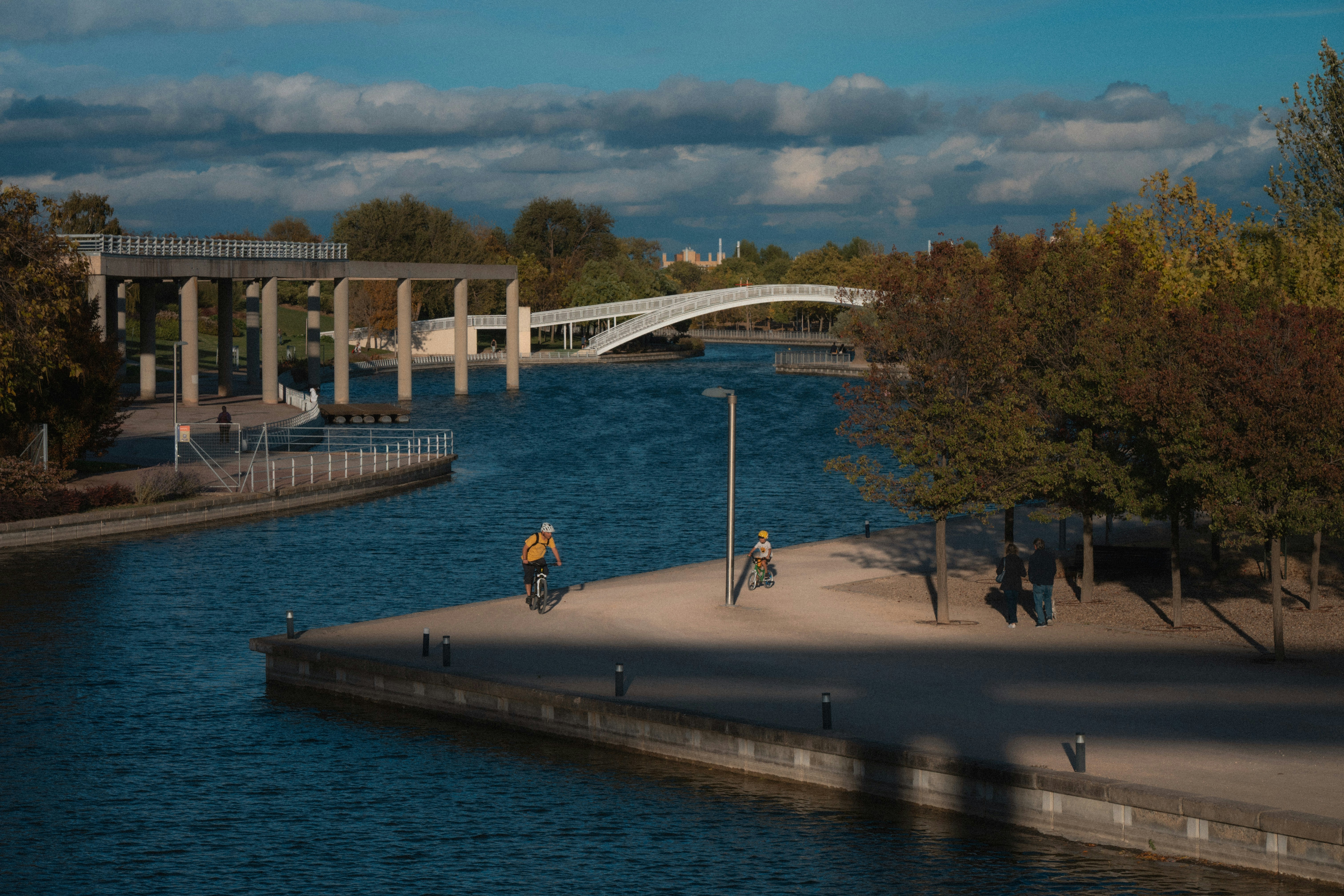 Pedestrian Platform Beneath a Riverside Bridge at Dusk