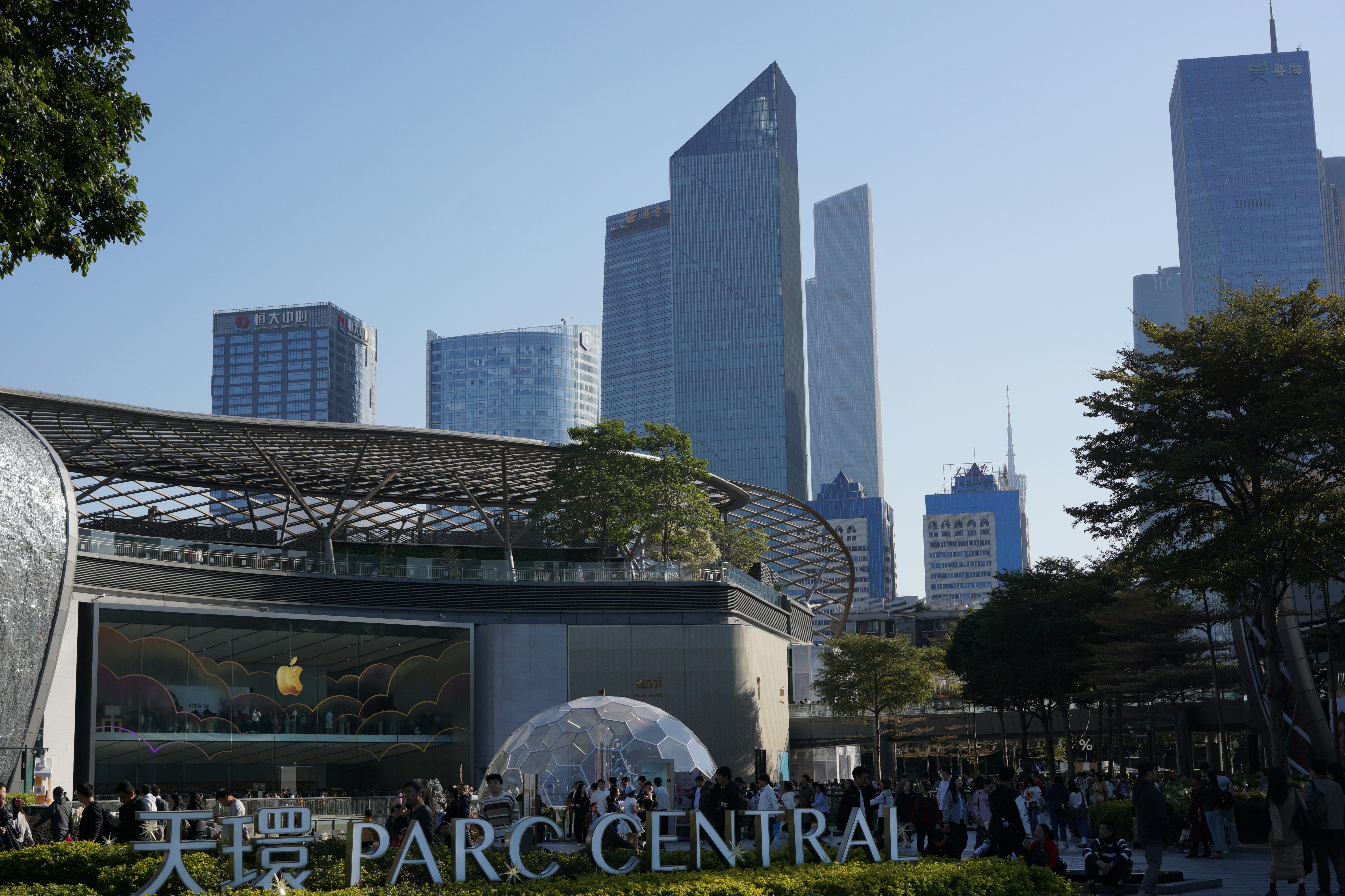 Parade of Glass and Green: Central Plaza under Skyscraper Canopy