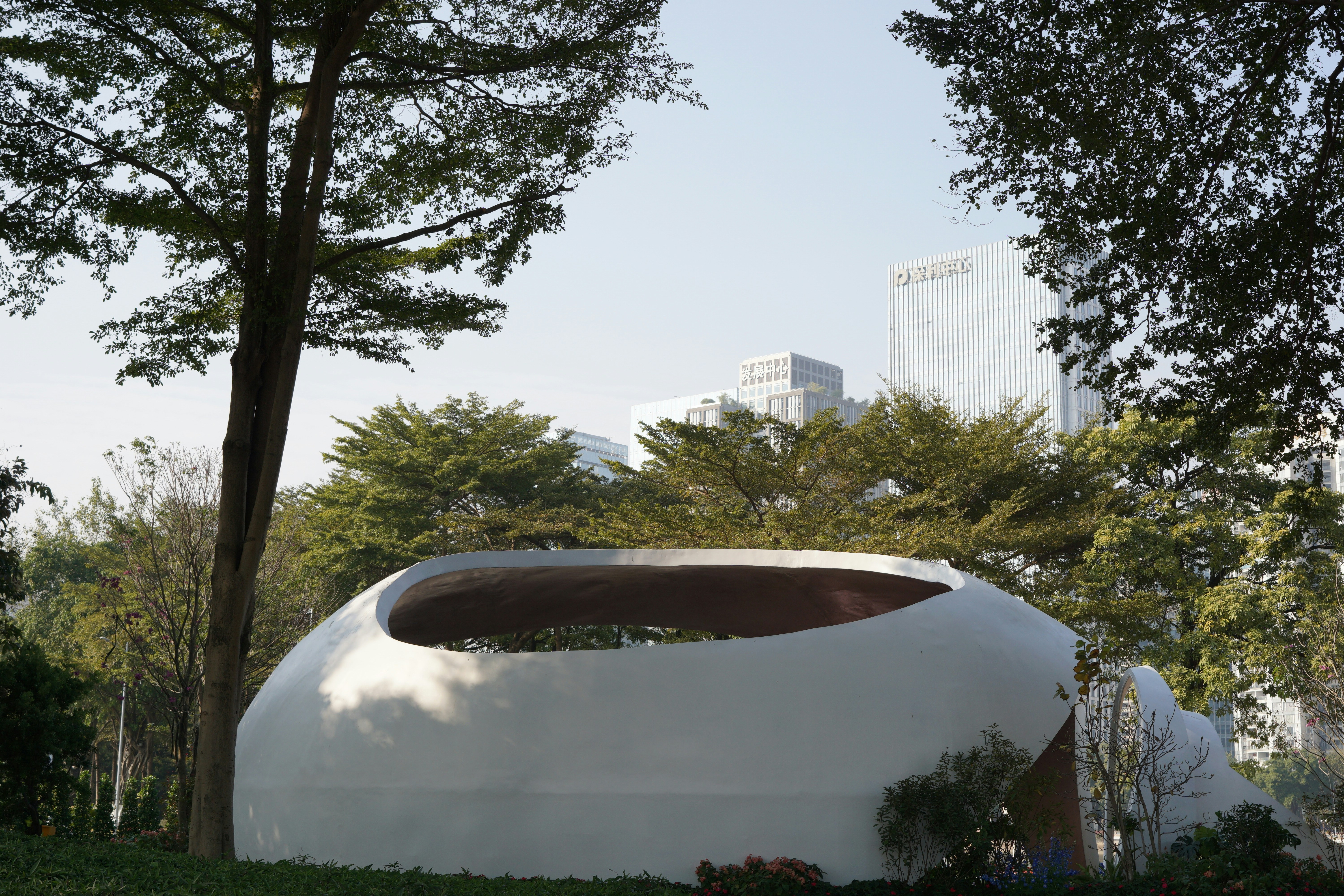 Orbiting Dome: Modern White Structure in a City Park