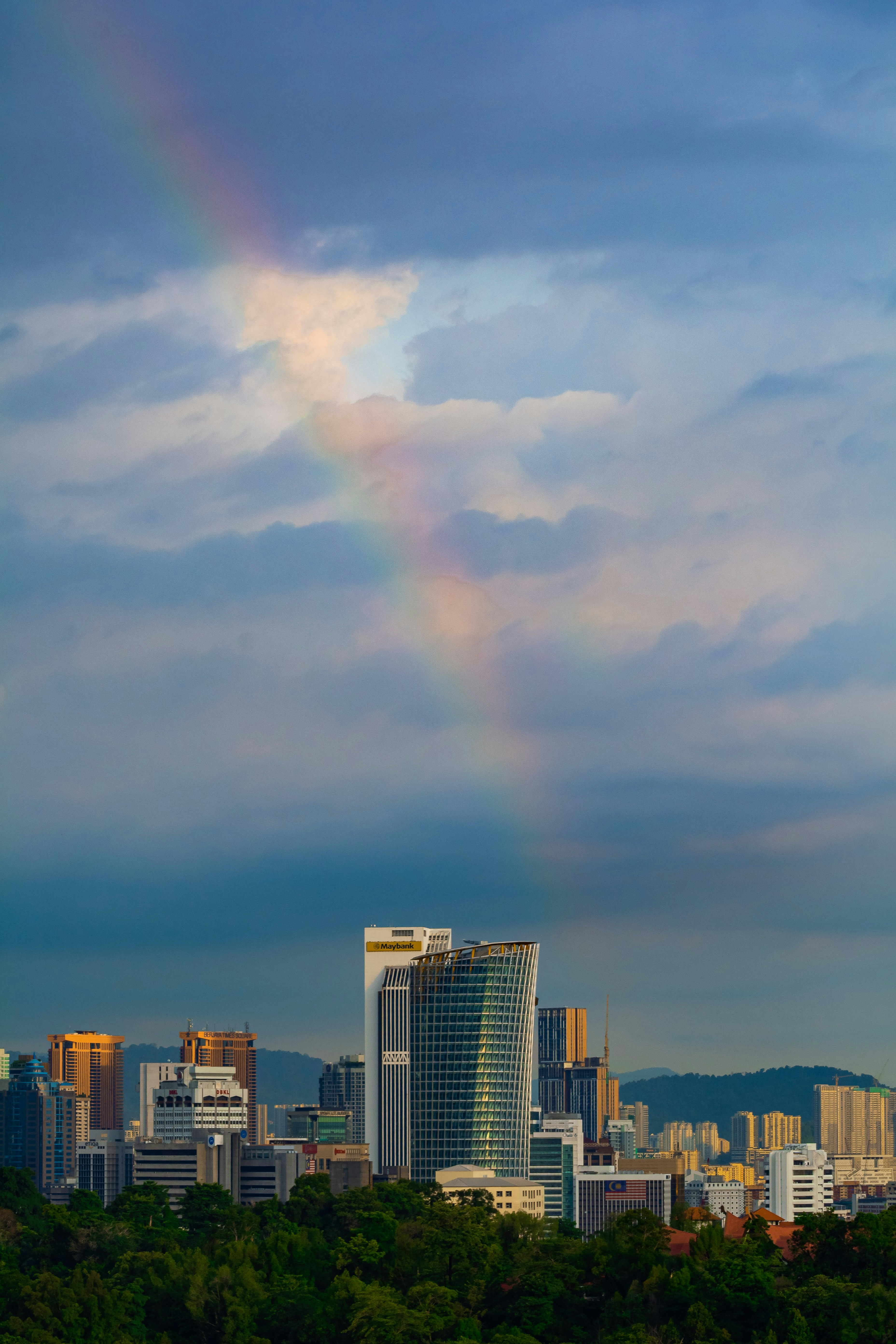 Rainbow Draped Skyline Over a Modern Cityscape