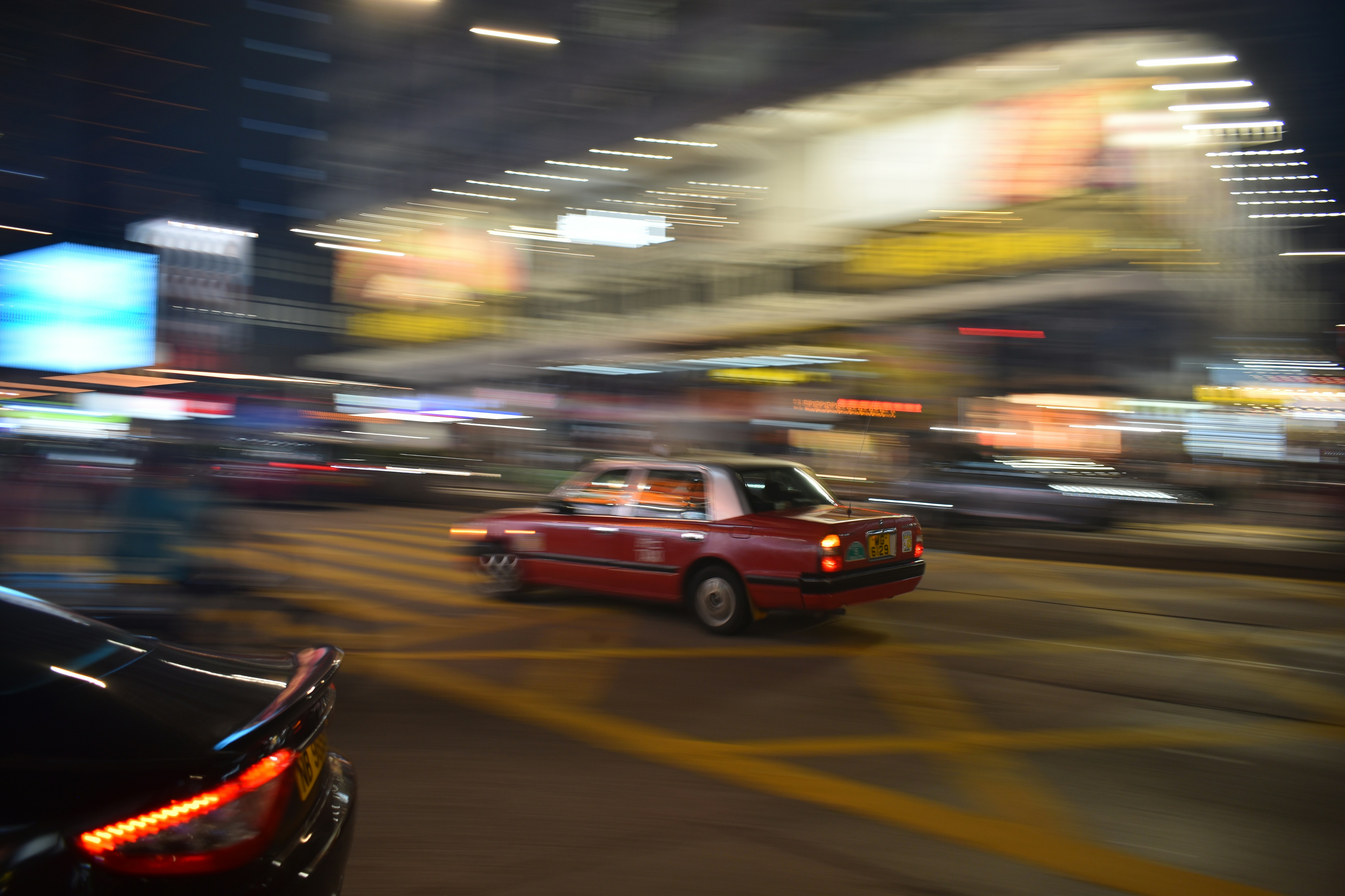 Neon Motion: Red Taxi in a Blurred City Pulse