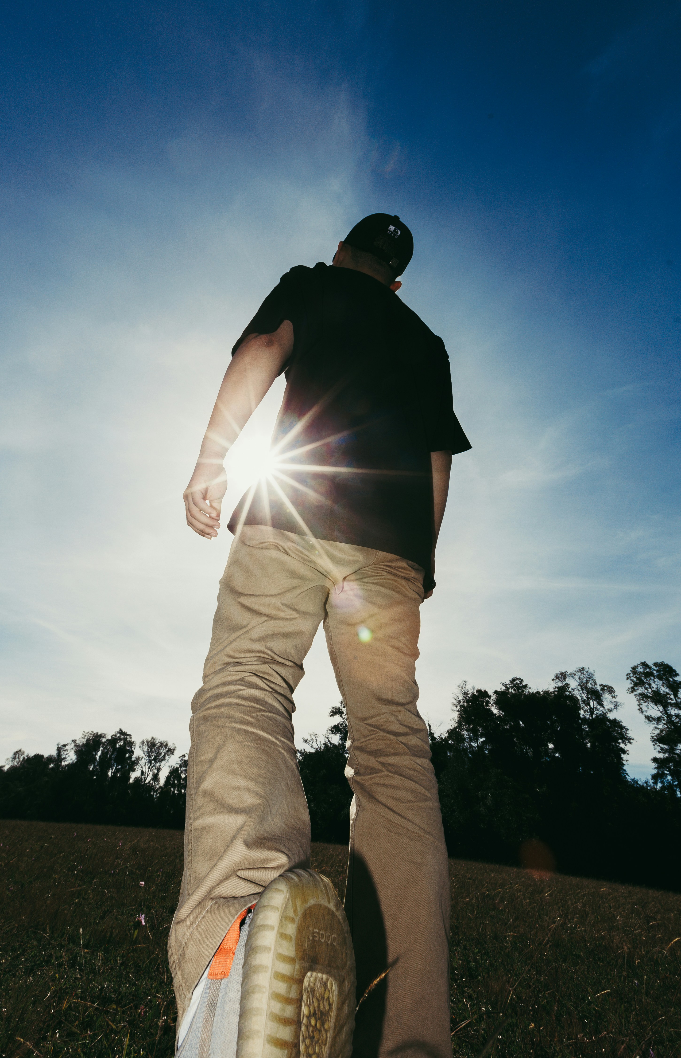 Backlit Ascent: A Runner Heads Toward the Sun