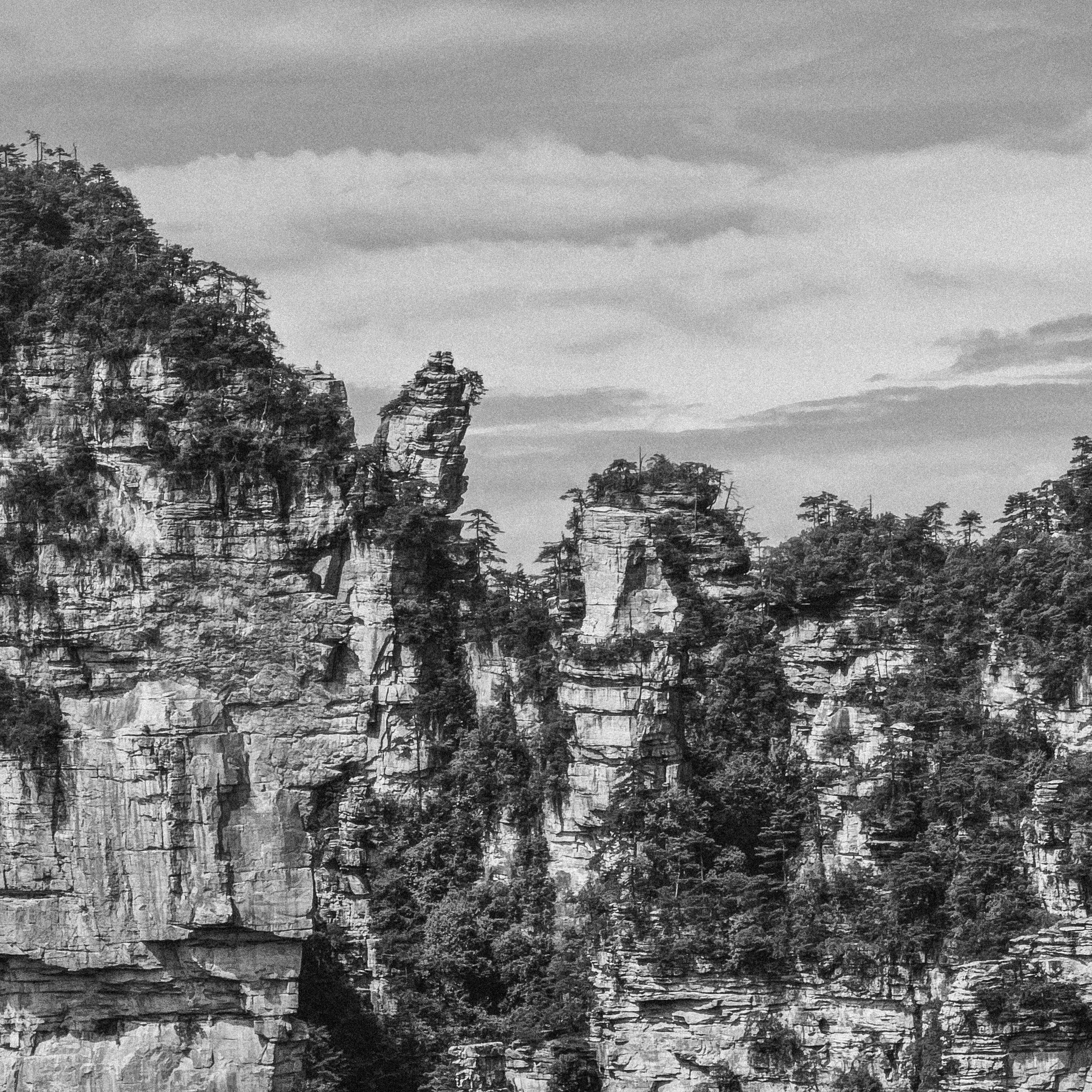 Stone Sentinels: Carved Peaks Against a Clouded Sky