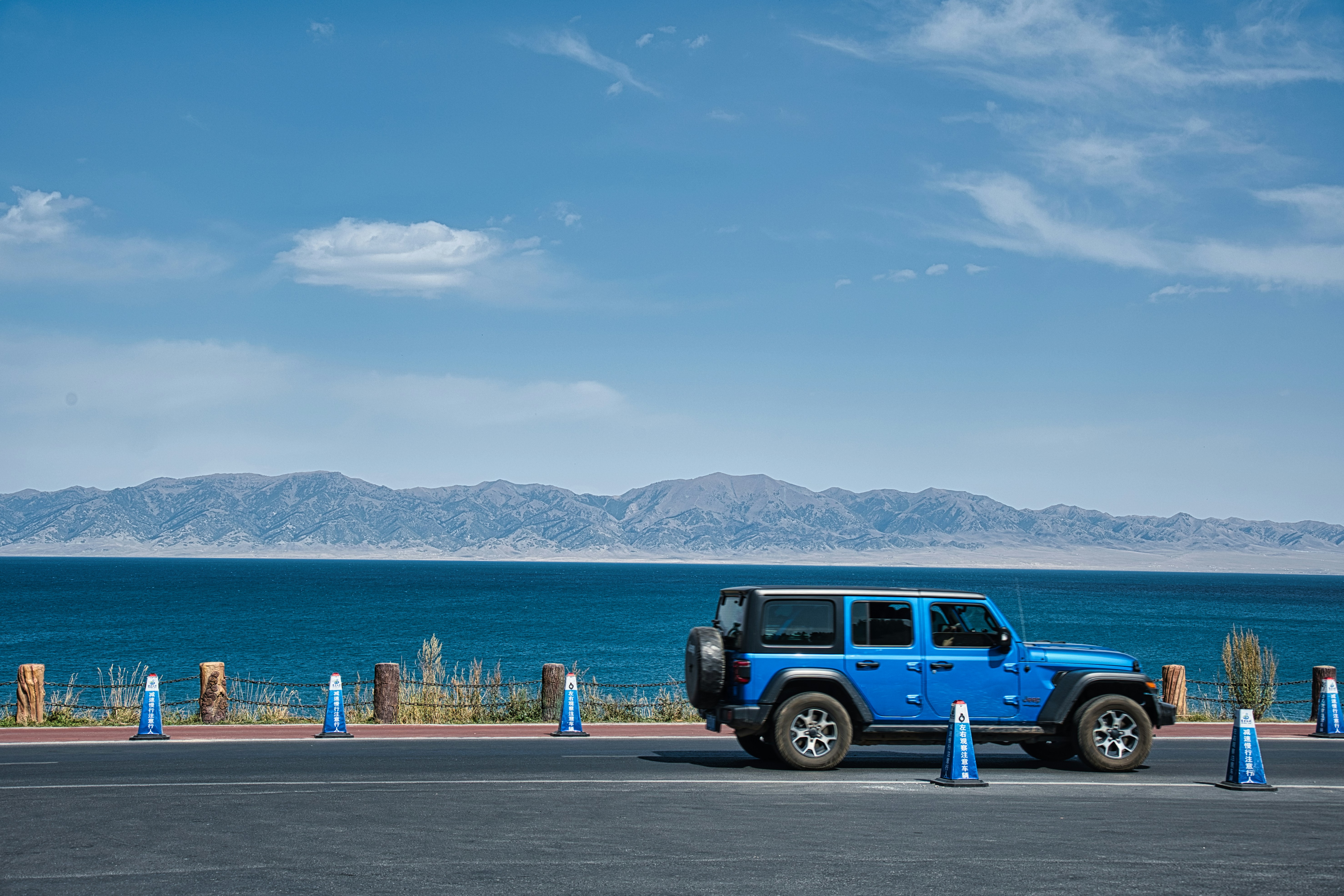 Blue Jeep by the Sea: A Quiet Coastal Parking Scene