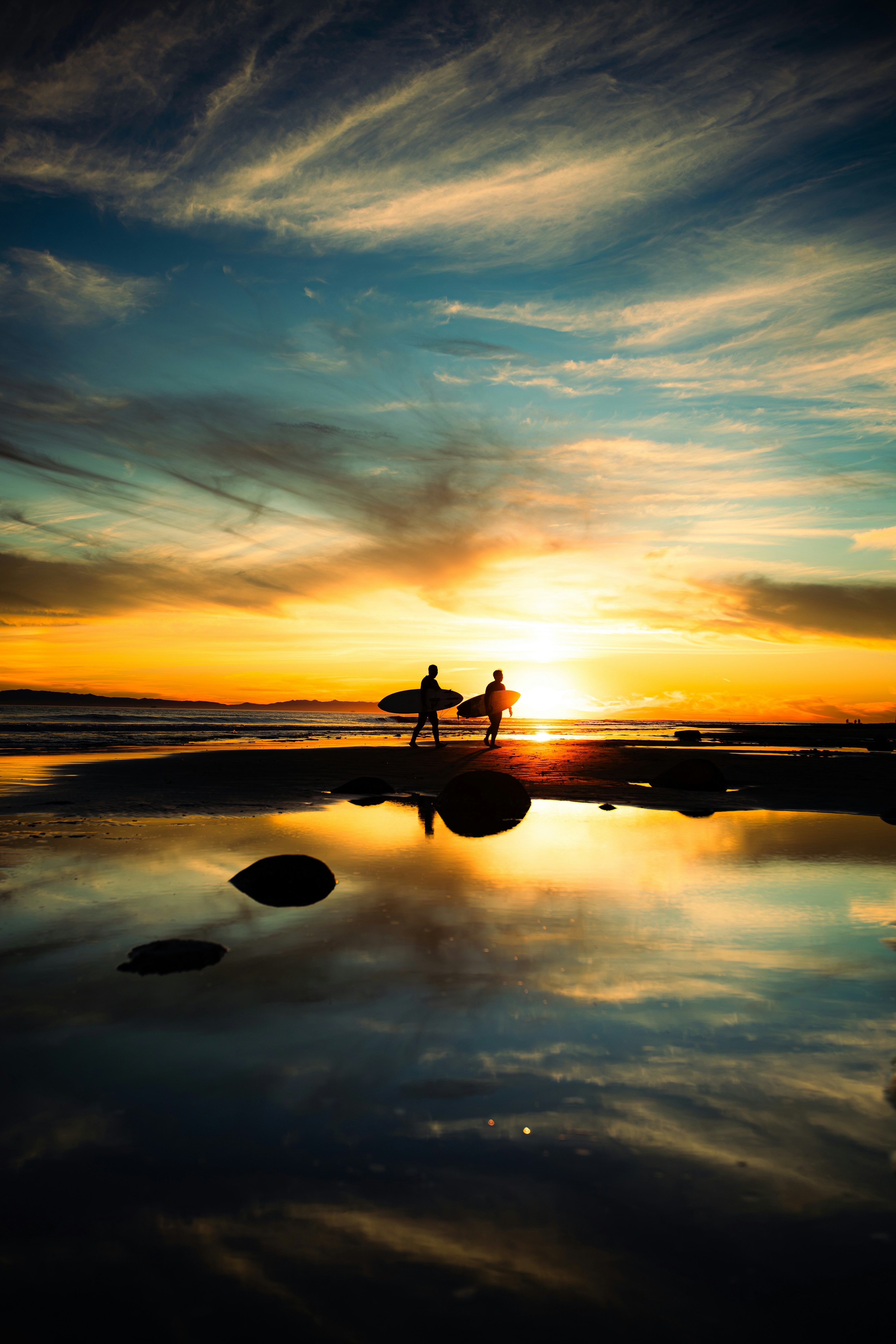 Silhouetted Surfers at Sunset
