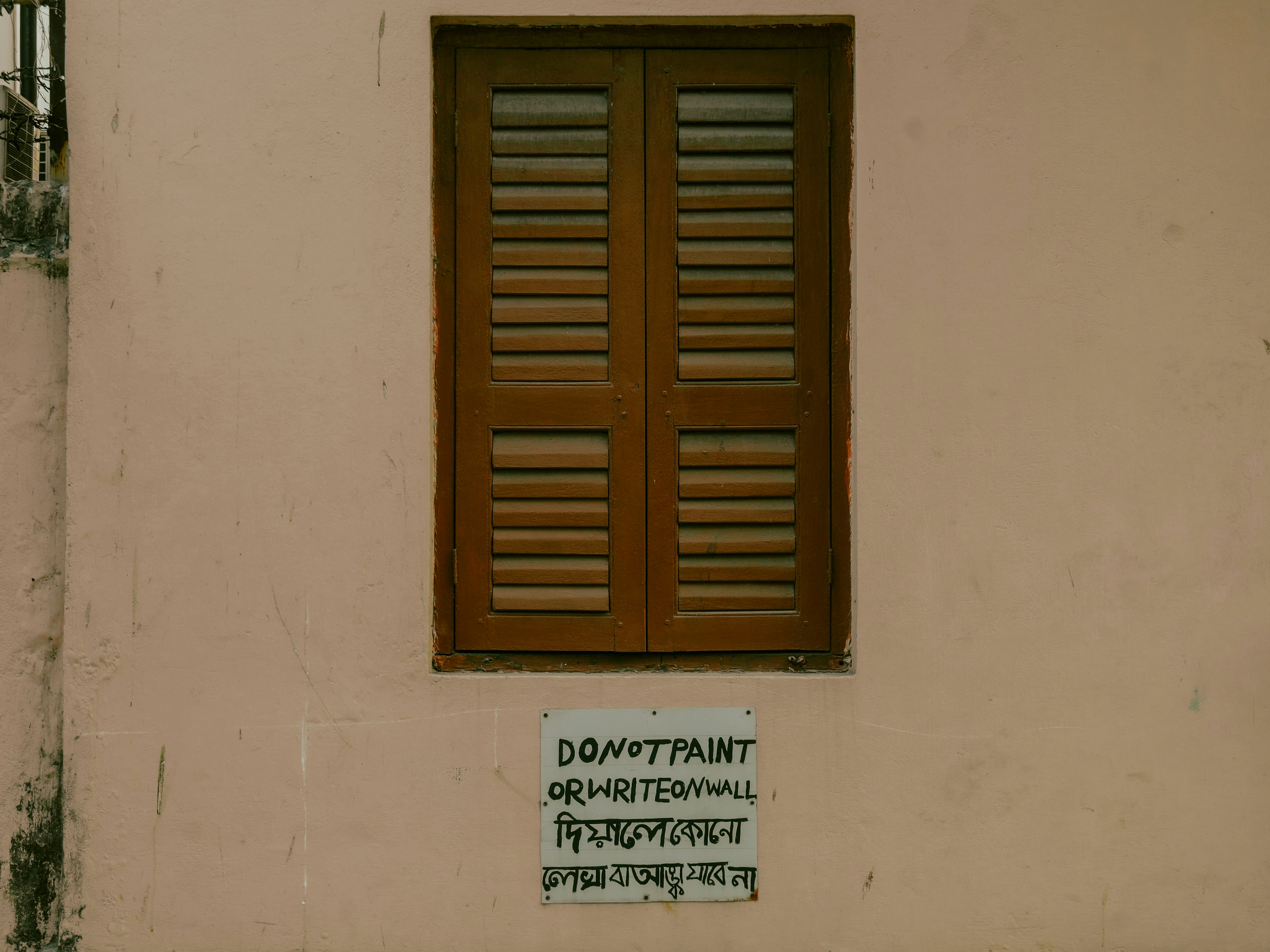 Weathered Window with Sign: Quiet Wall of Purpose
