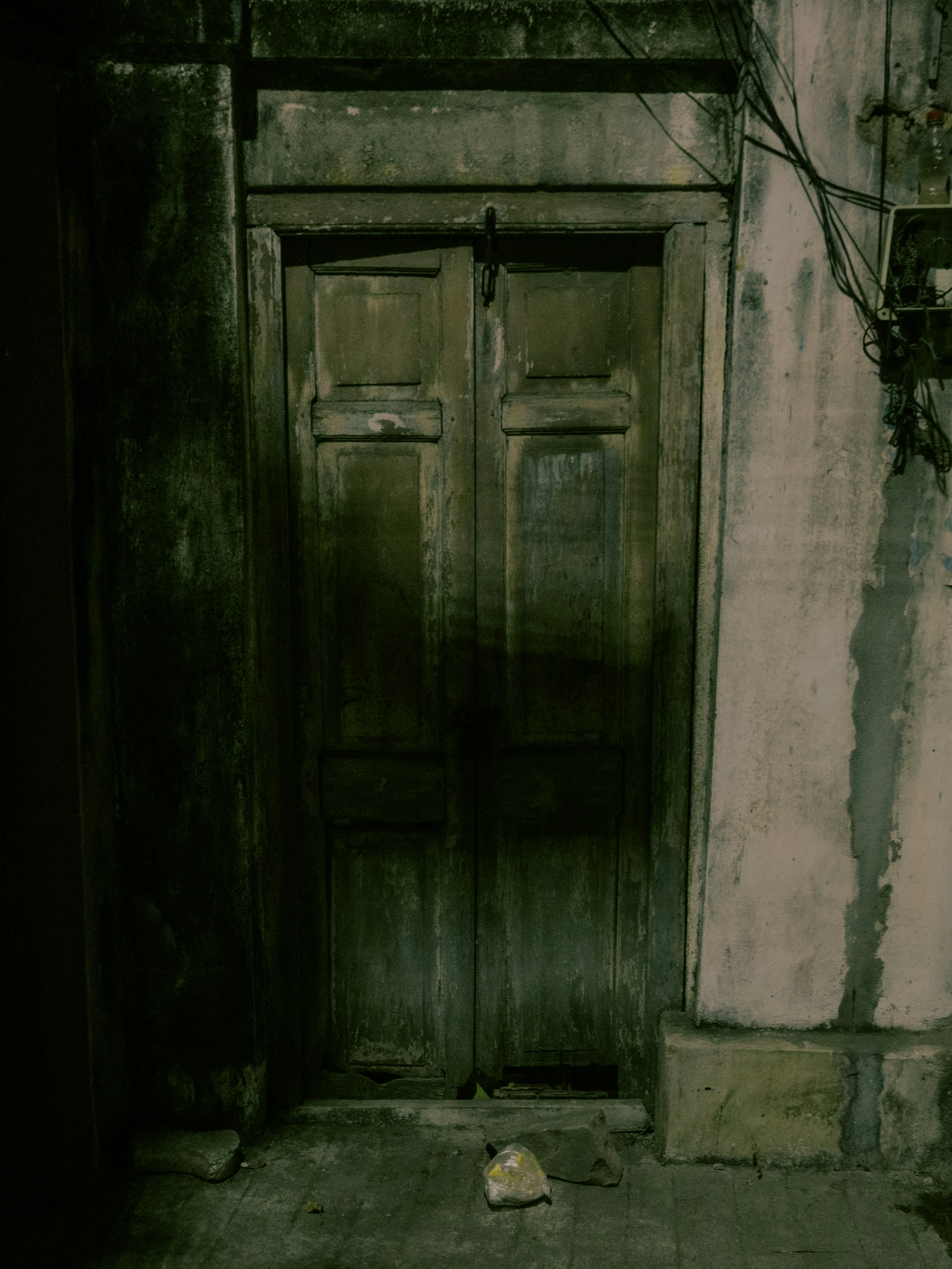 An old wooden door on a weathered building photo – Free Vintage Image ...