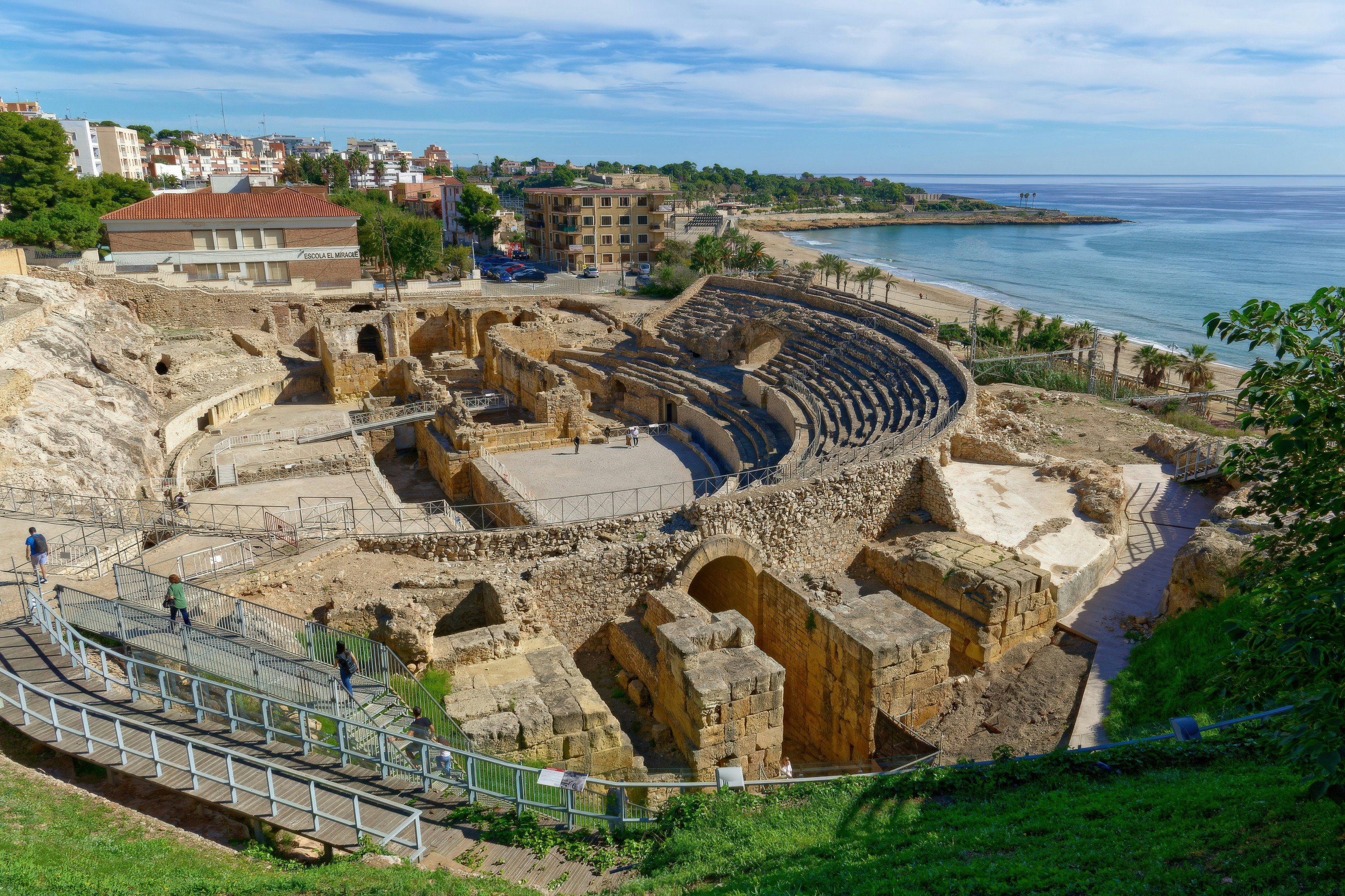 Ancient roman amphitheater overlooking the mediterranean sea.