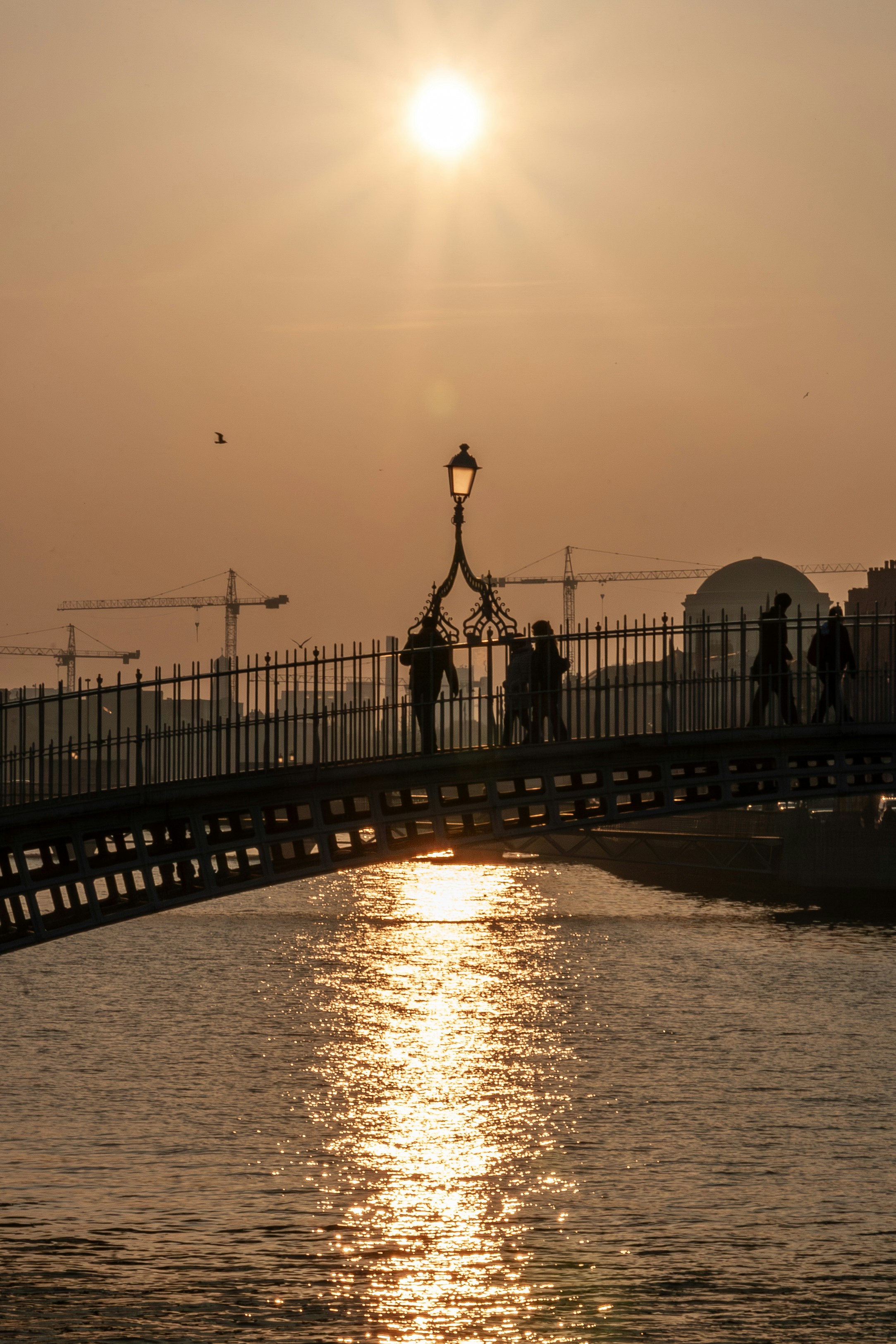 Golden Hour at the Bridge: Silhouettes and Lantern Light