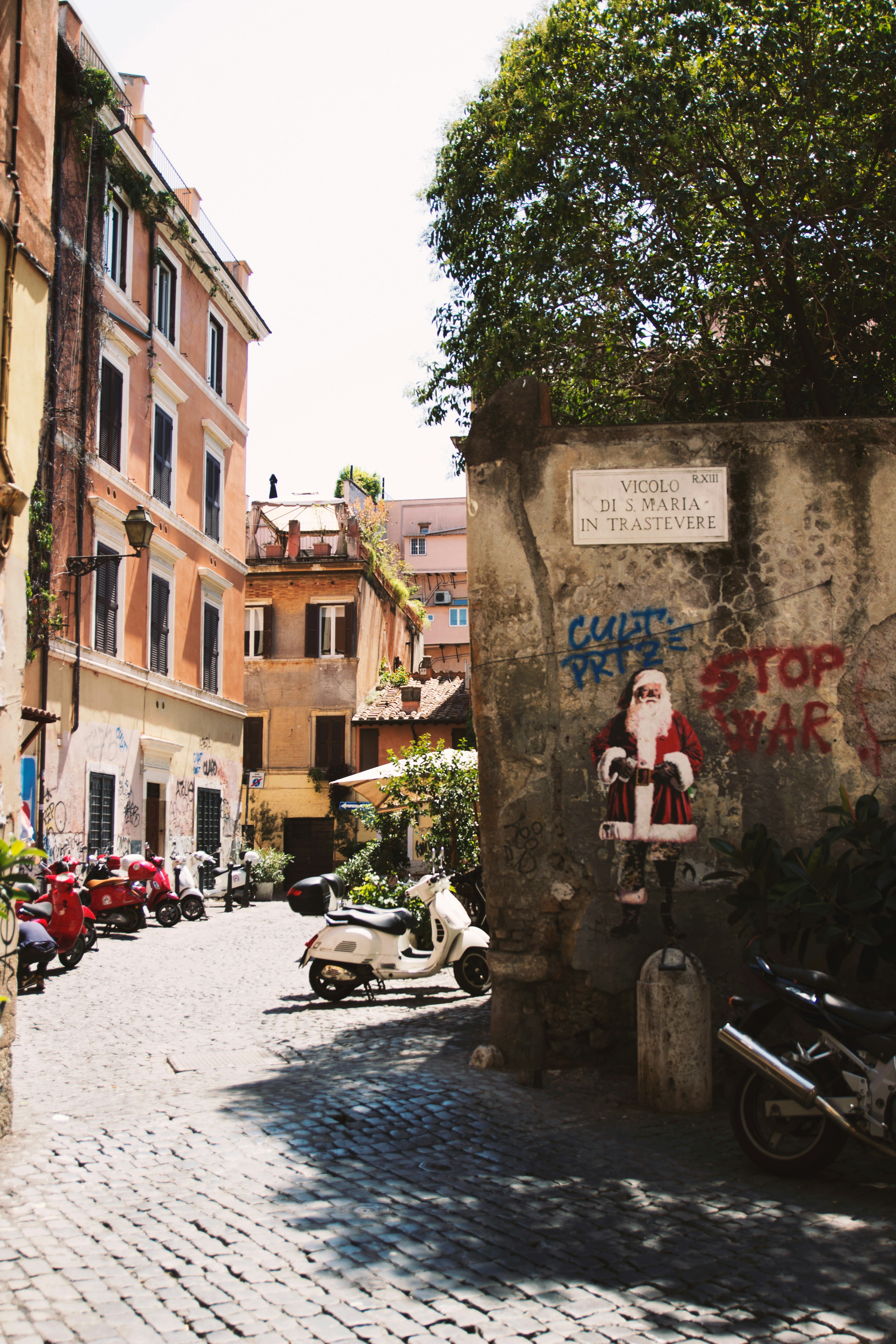 Sunlit Alleyway with Graffiti Santa and Vespa Constellation