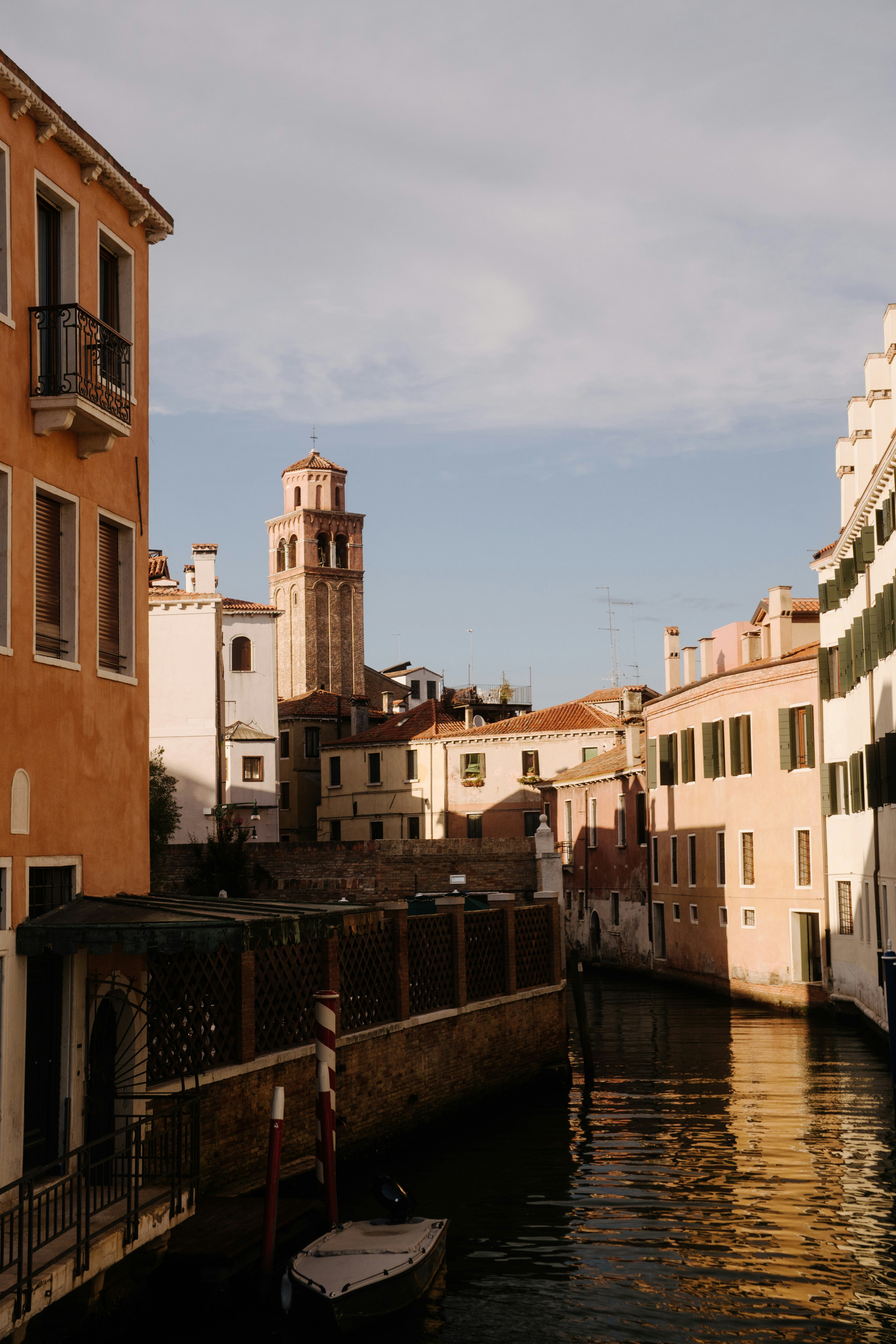 Canal Reflections and Towerline in a sunlit Venetian-leaning Alley