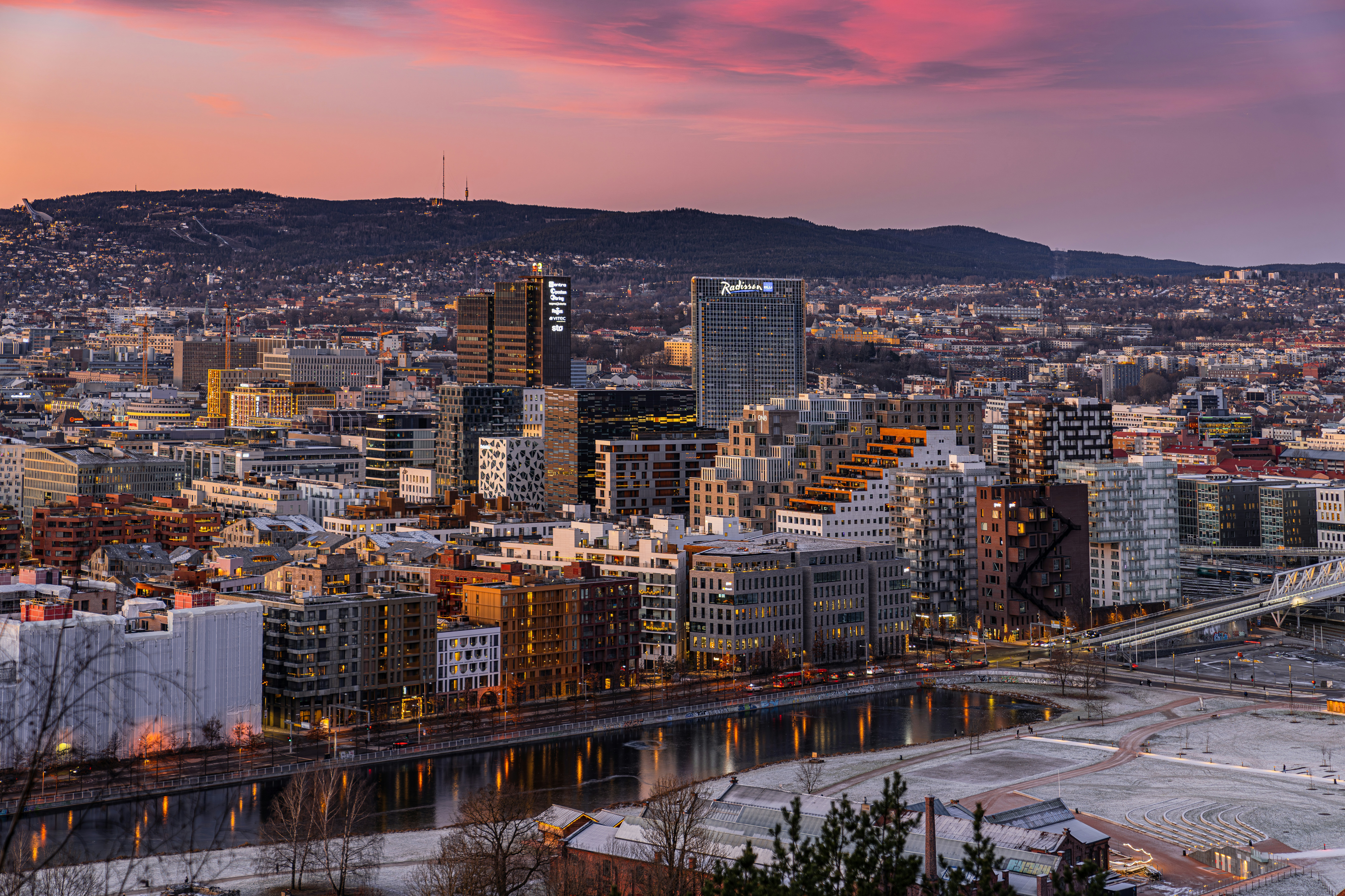 Sunset Cityscape Over the River: Glassy Skyline and warm Reflections
