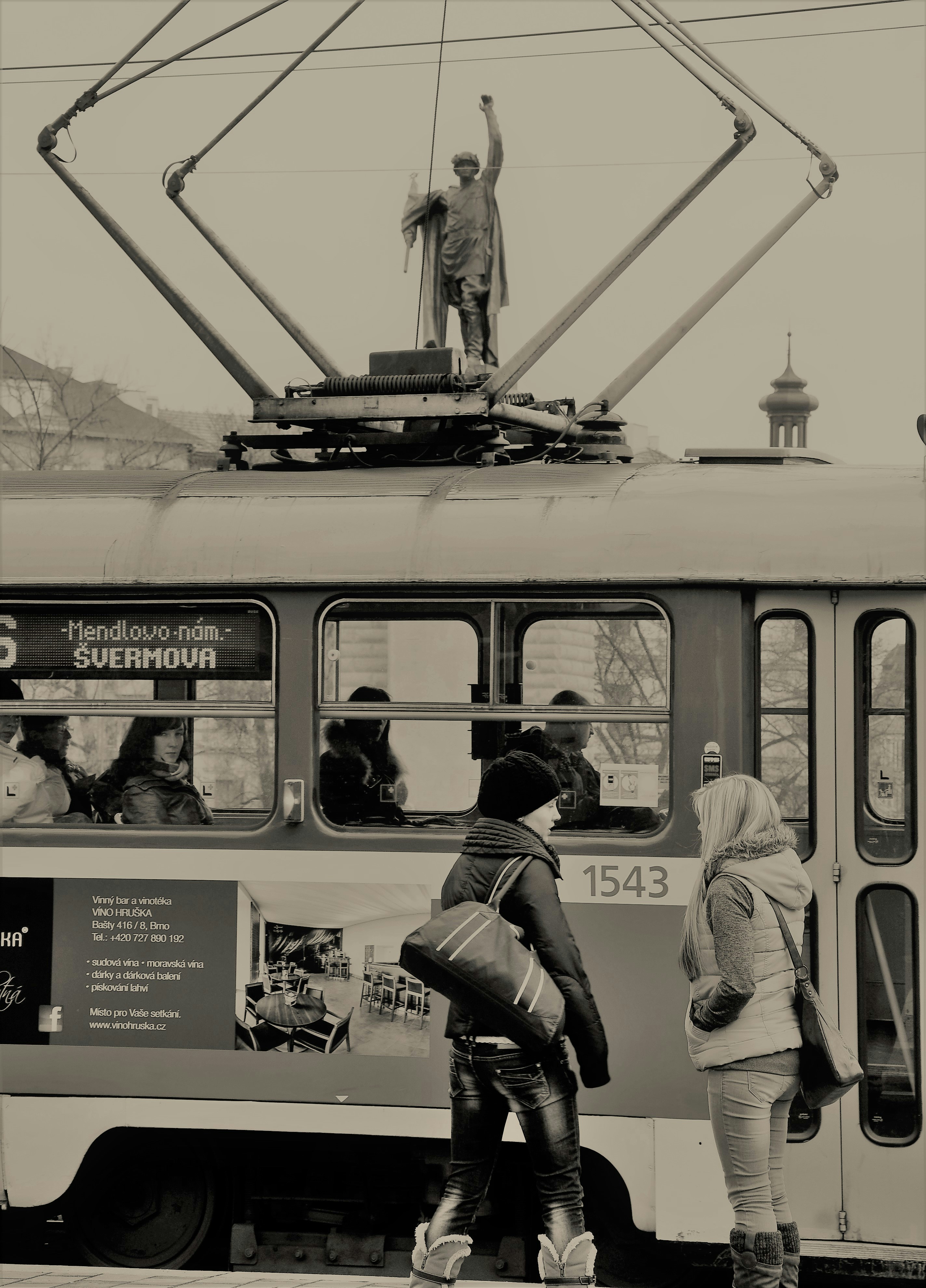 Hero atop Transit: A Monumental Figure Over a City Bus