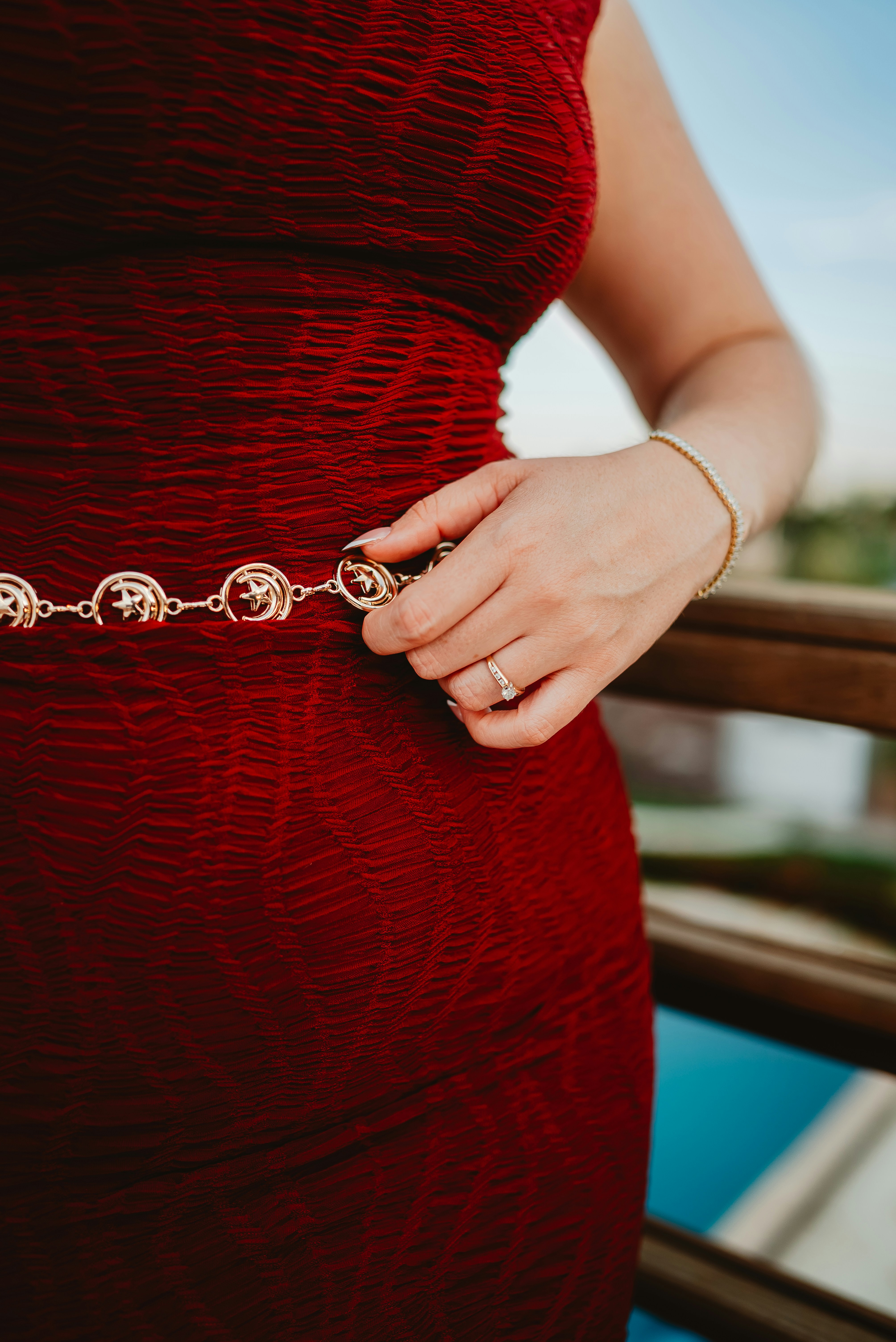Crimson Textures: A Close Up of Lace, Belt, and Ring Details