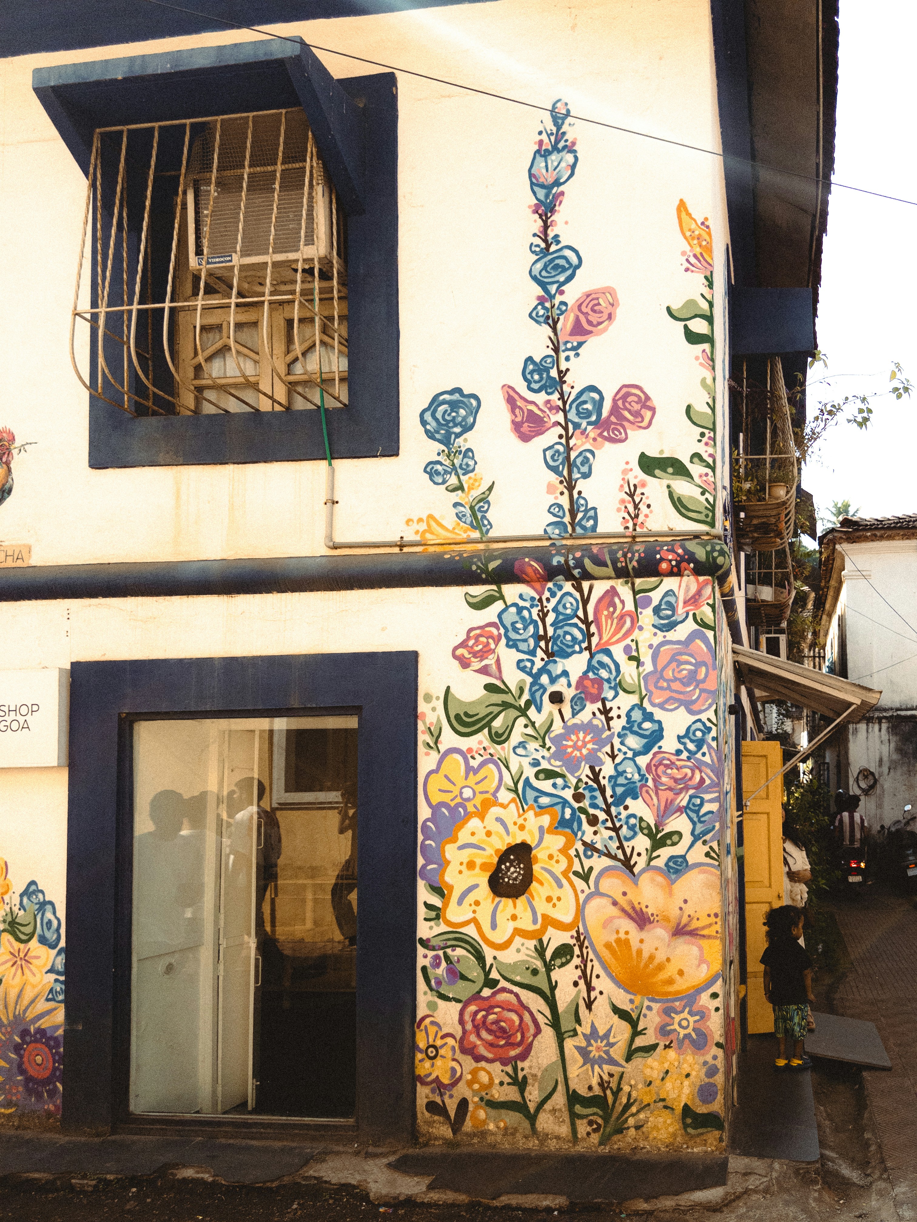 Urban mural with vivid florals framing a doorway