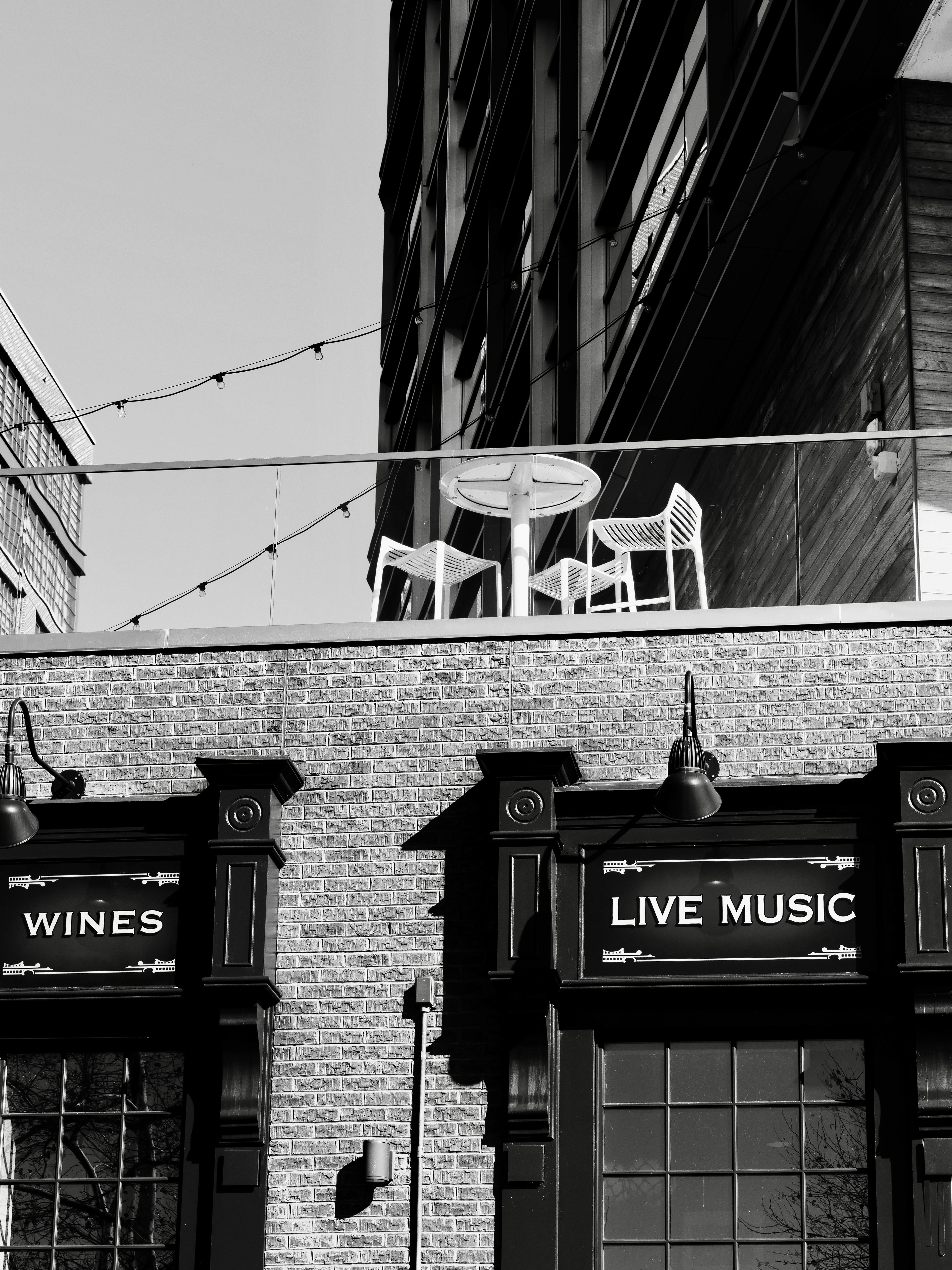 String Lights Above a Quiet Street Corner Café Scene