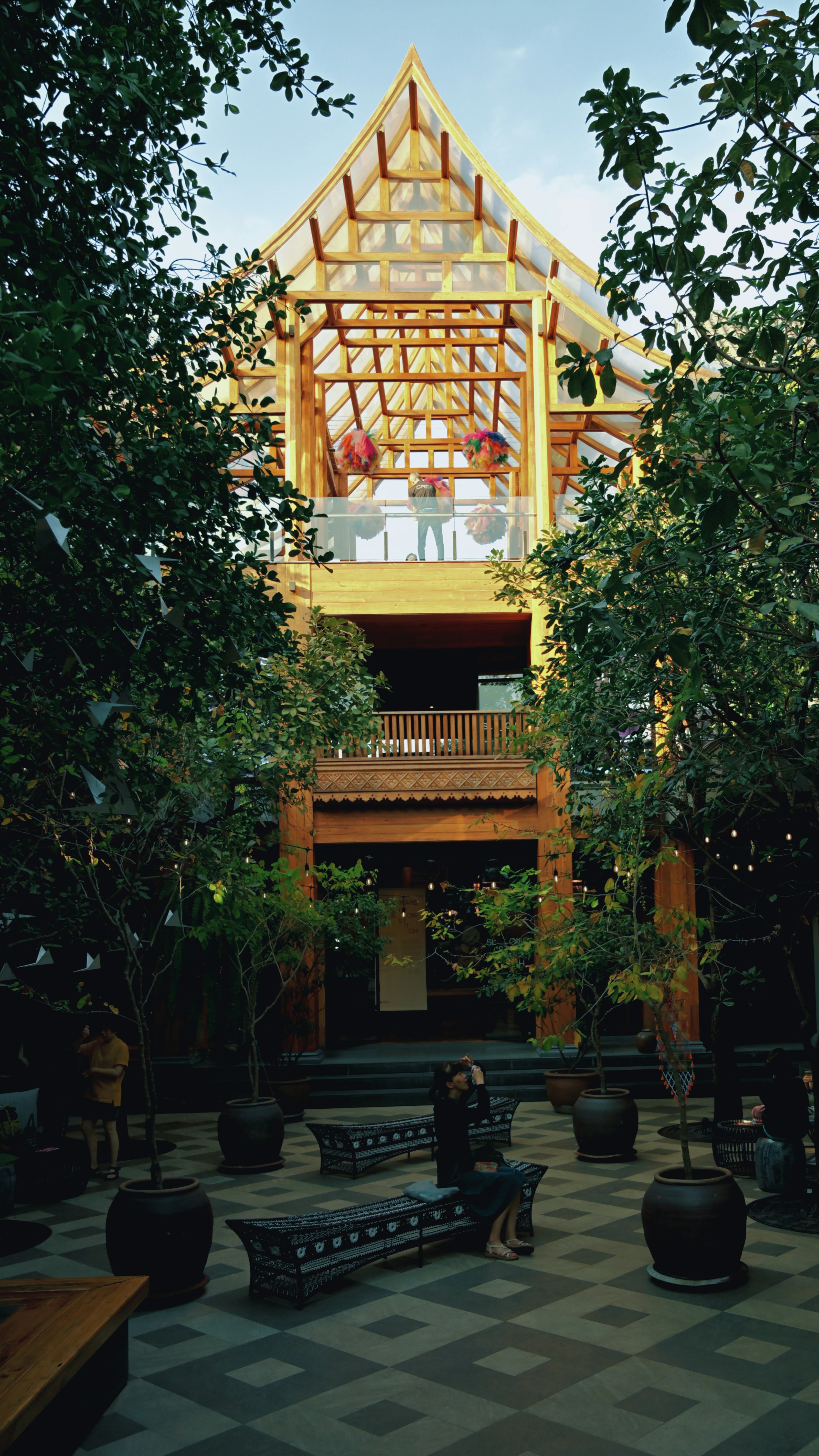 Sunlit Glass-Attic Atrium: Cedar Frame House Rising Above Courtyard