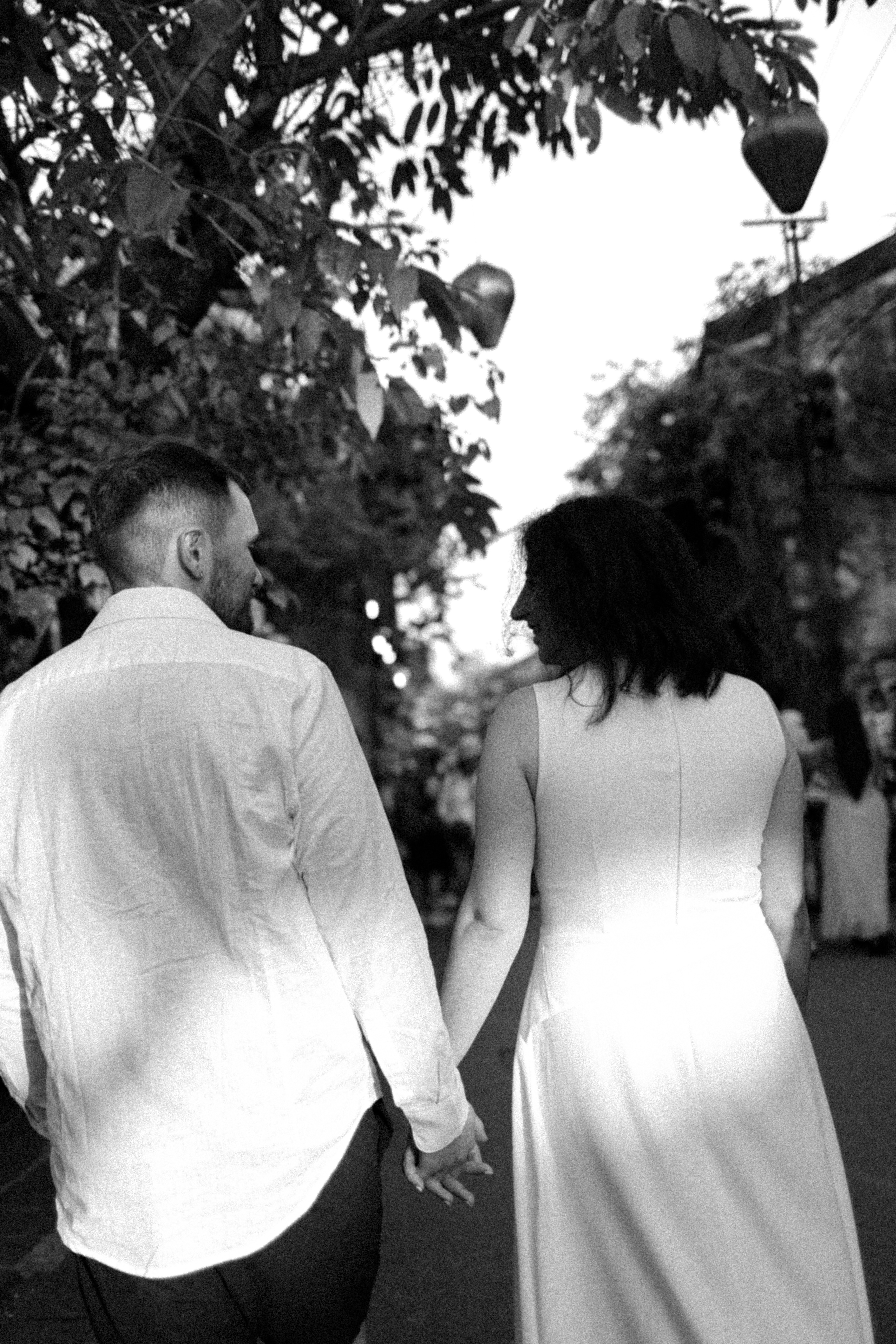 Holding On Between White Attire: A Night Walk Portrait