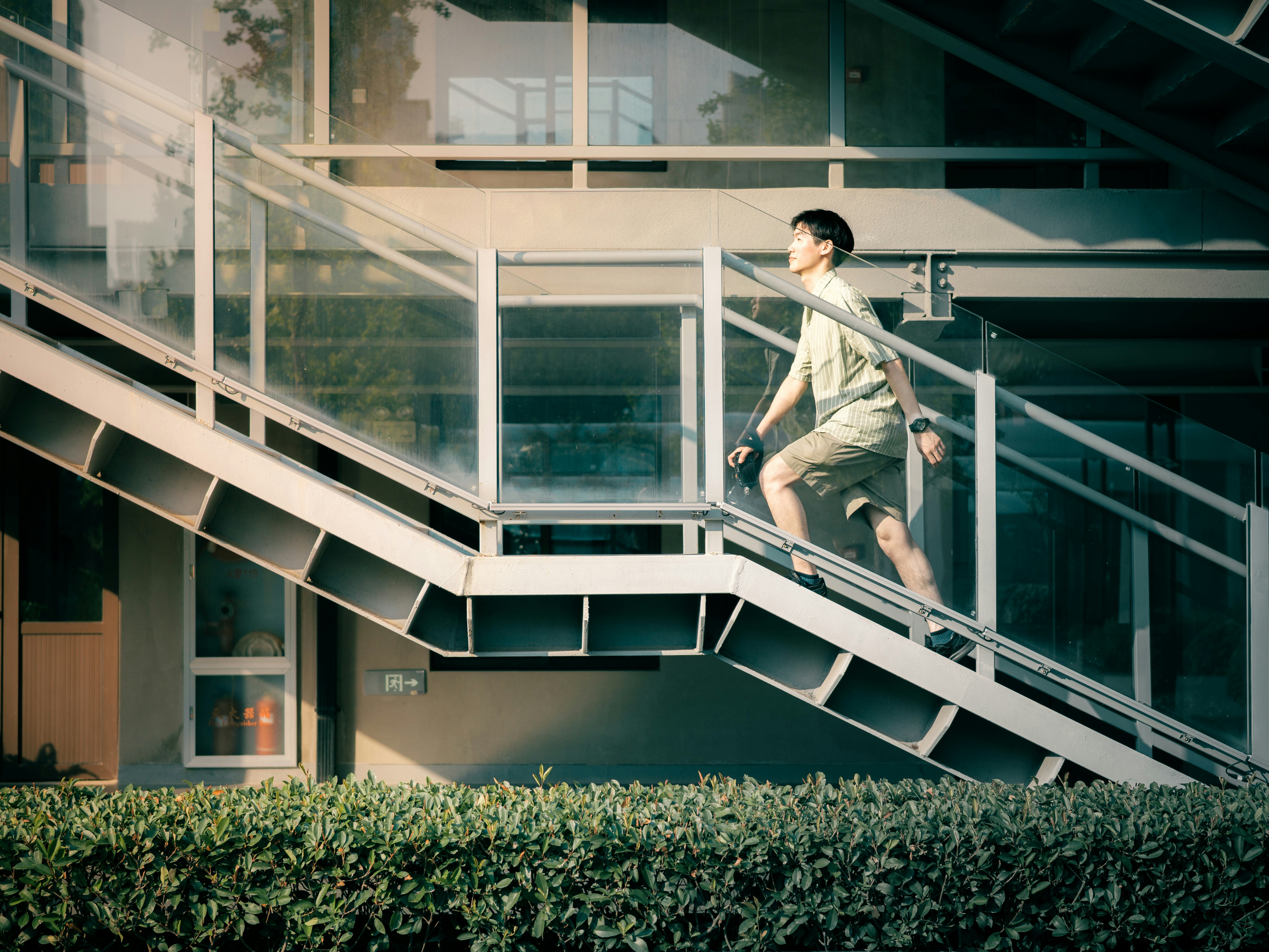 Runner on a Glass Staircase: Motion Framed by Modern Architecture