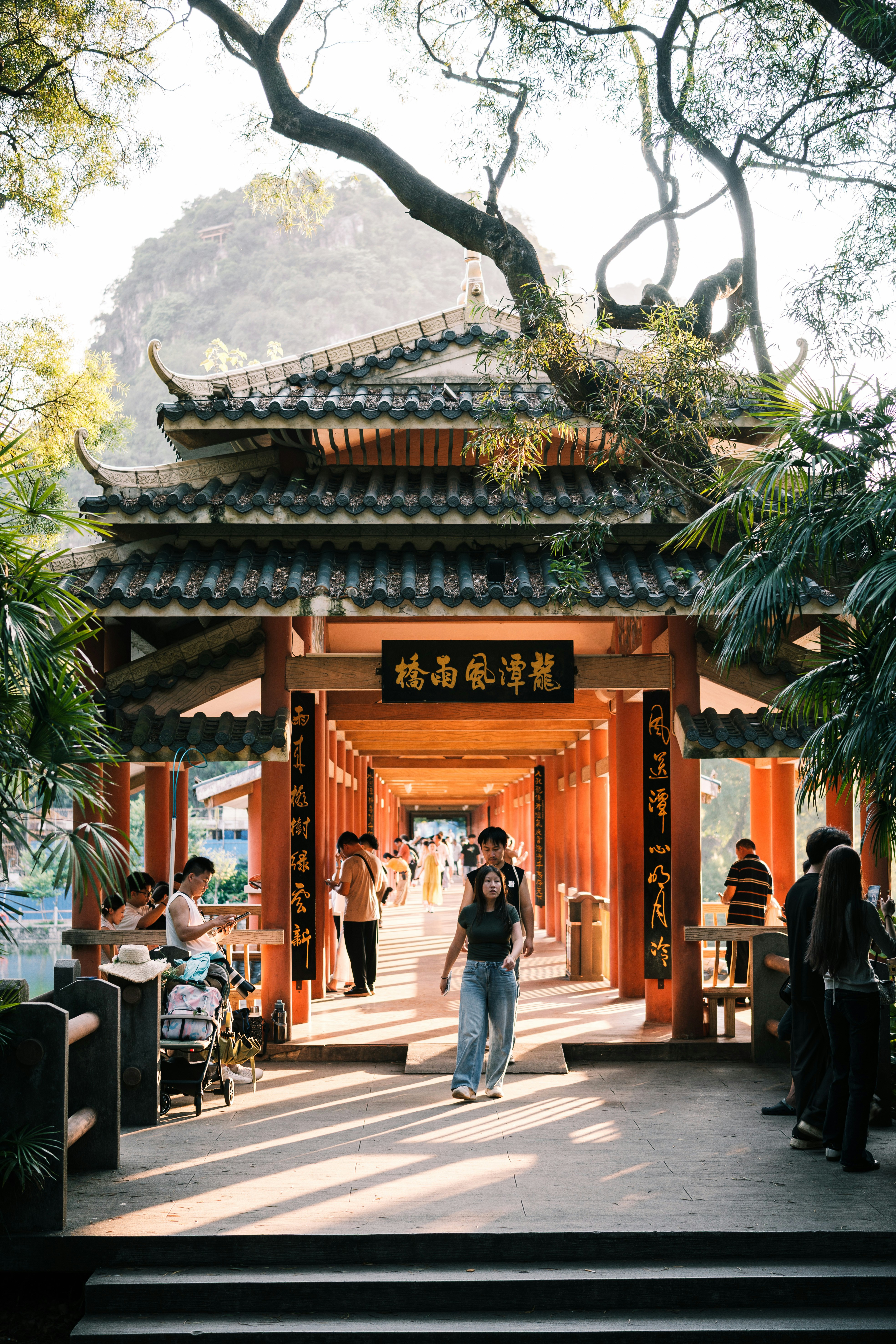 Red Corridor of Lanterns: People Wander Through a Traditional Chinese Pavilion