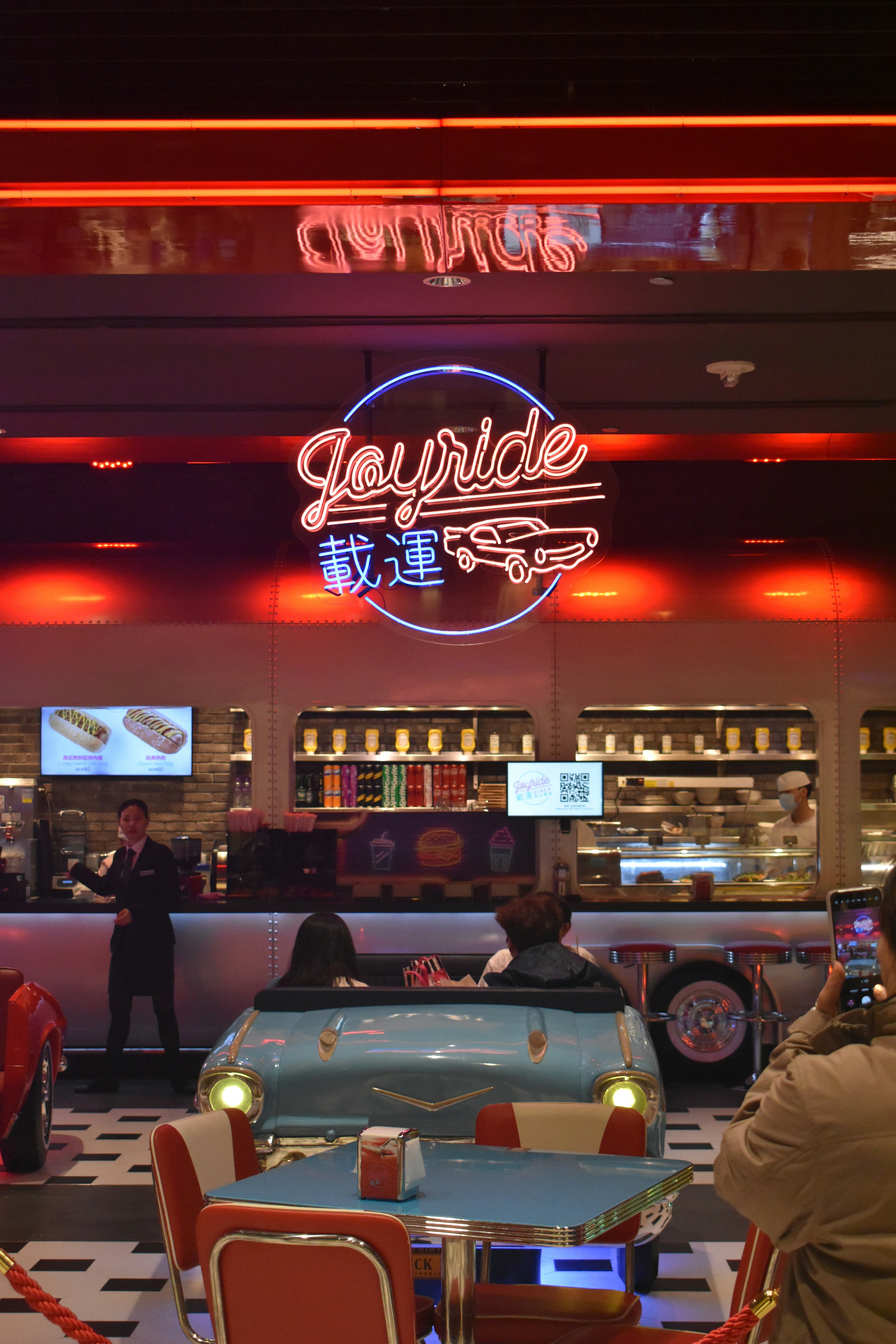 Neon Retro Drive-In: A Blue Convertible Under a Spark of Lights