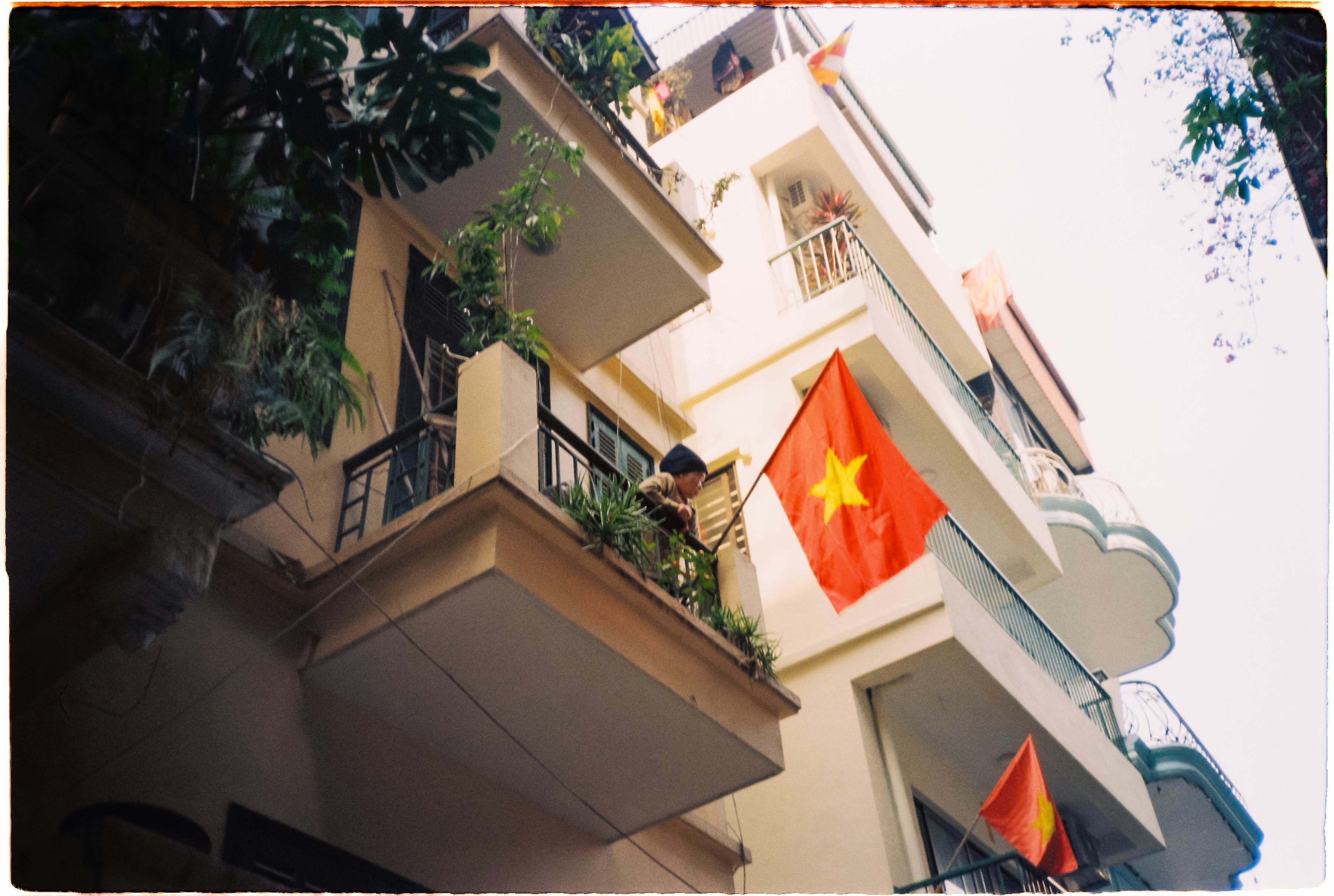 Flag-draped Balcony: A Slice of Urban Life