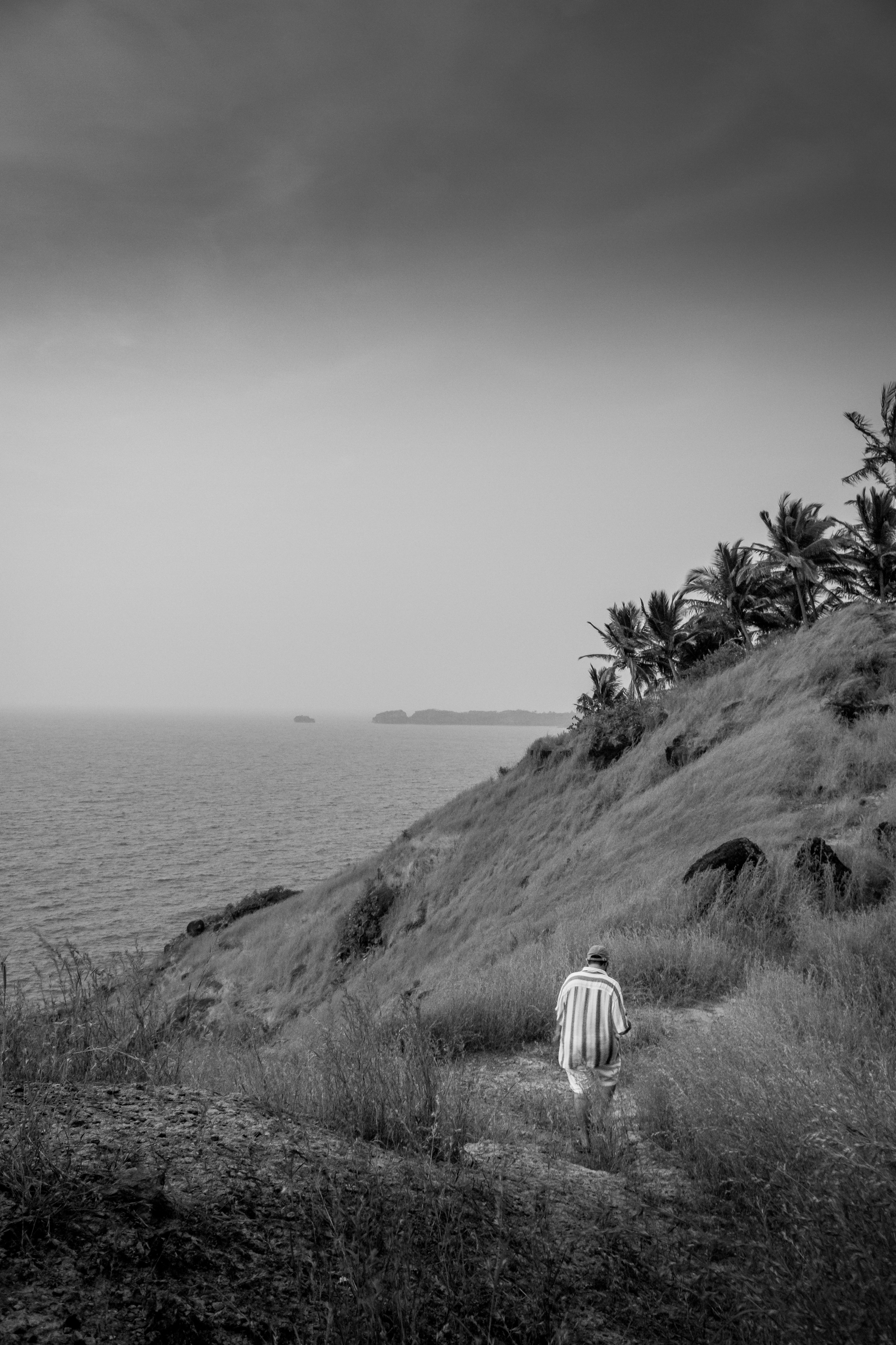 Trail to the Sea: A solitary figure on a windswept hillside