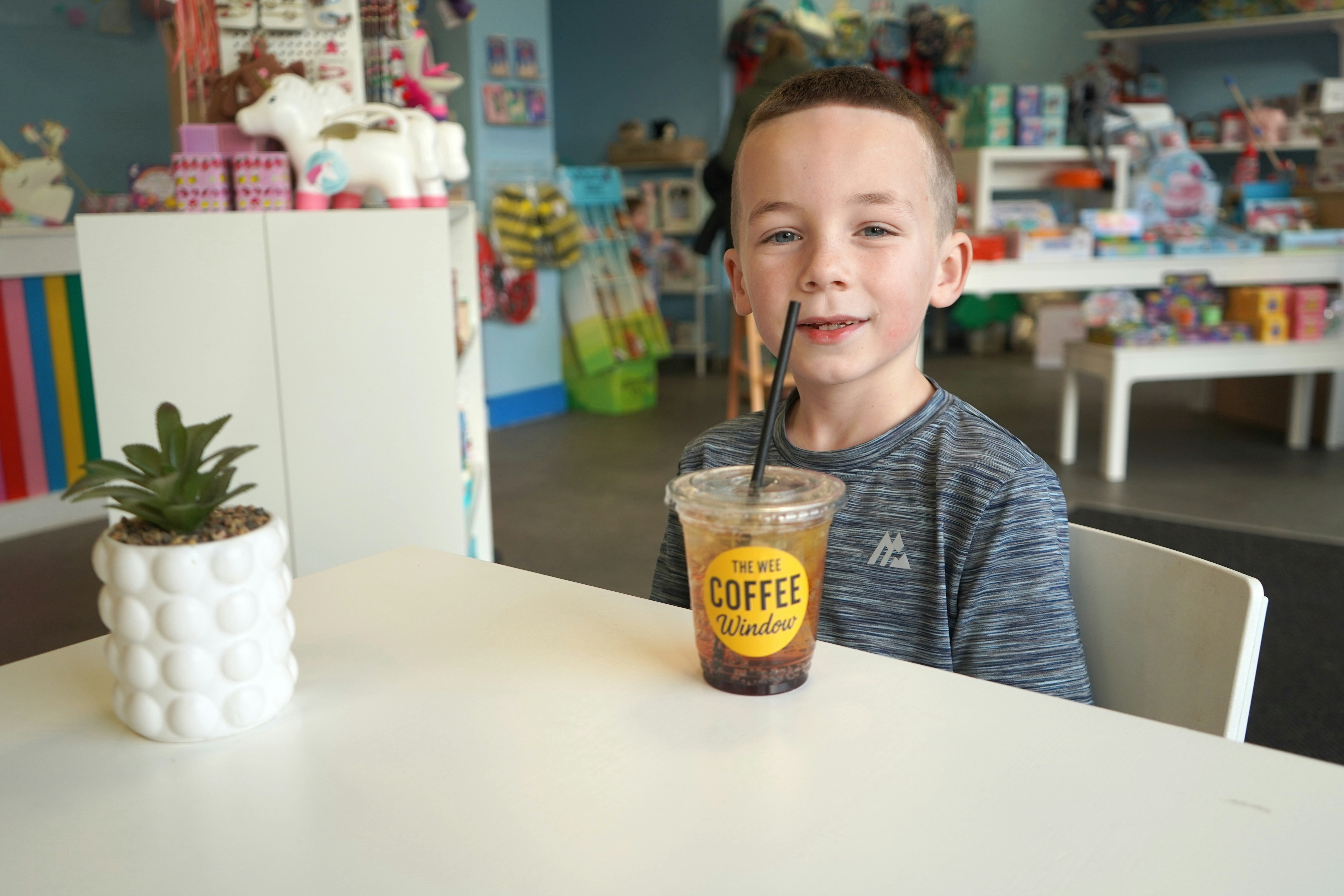 Sipping Joy: A Café Moment with a Curious Smile