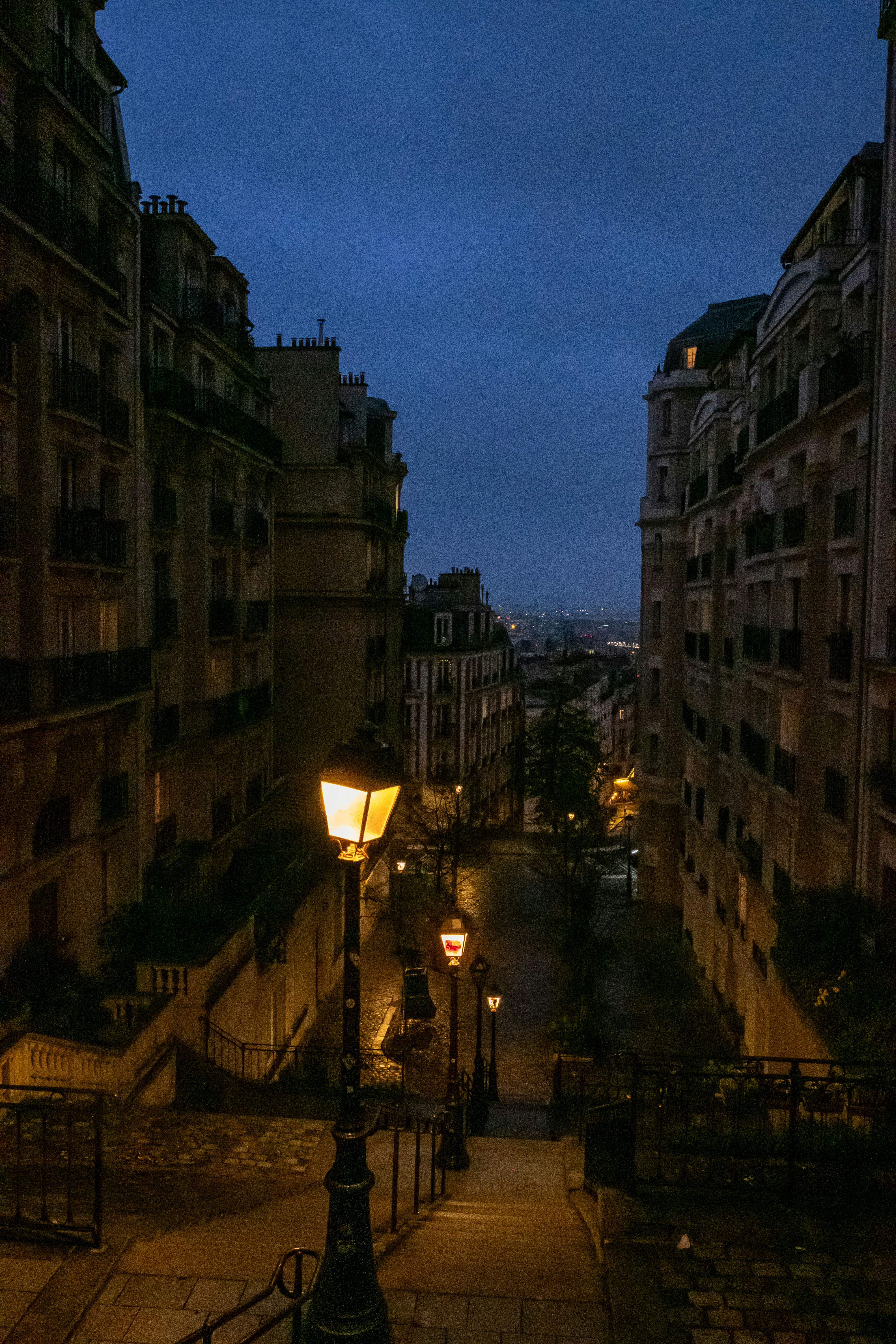 Lantern-lit Alleyway Between Parisian Facades at Dusk