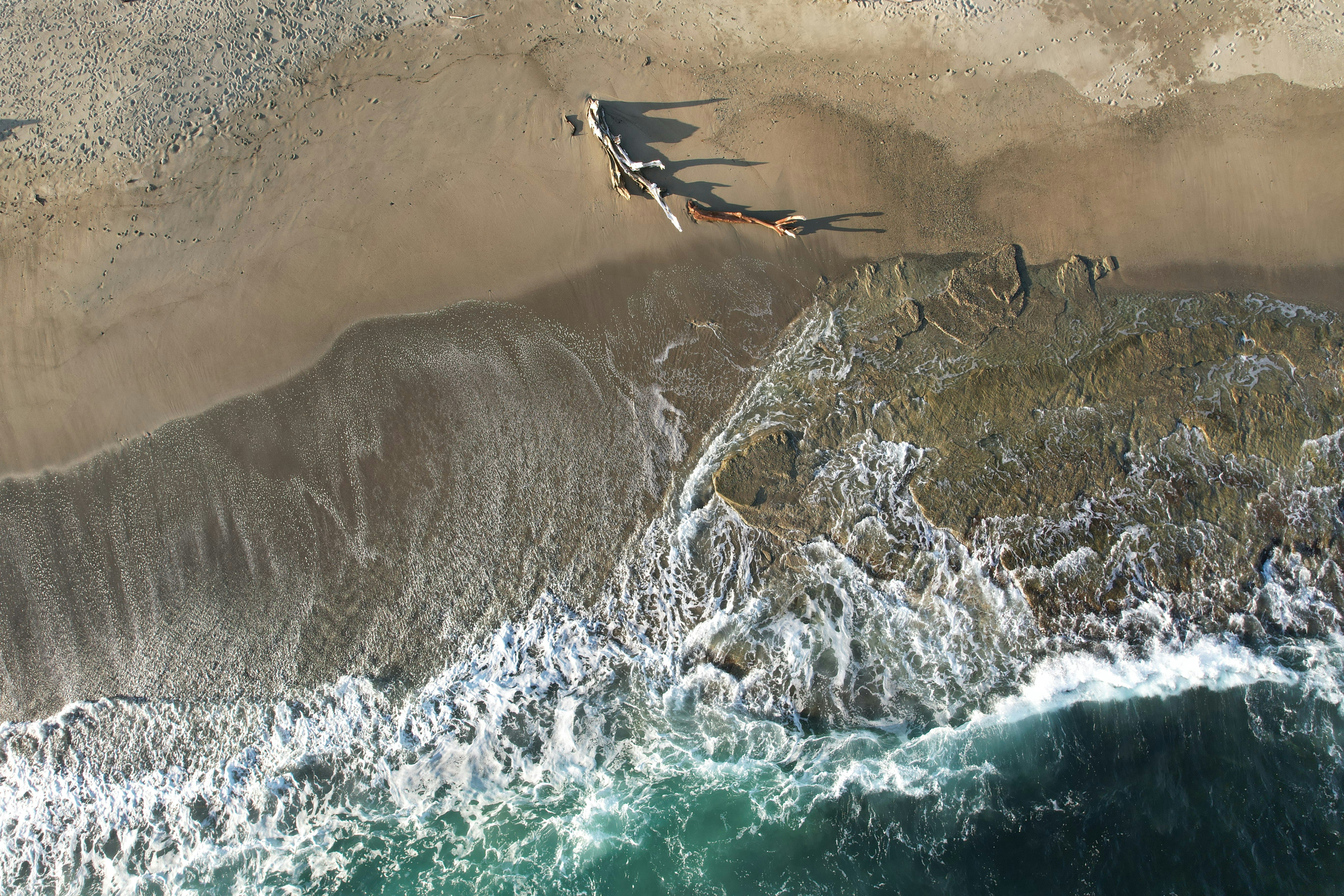 Coastal Drift: Aerial View of Tidal Break on the Shore