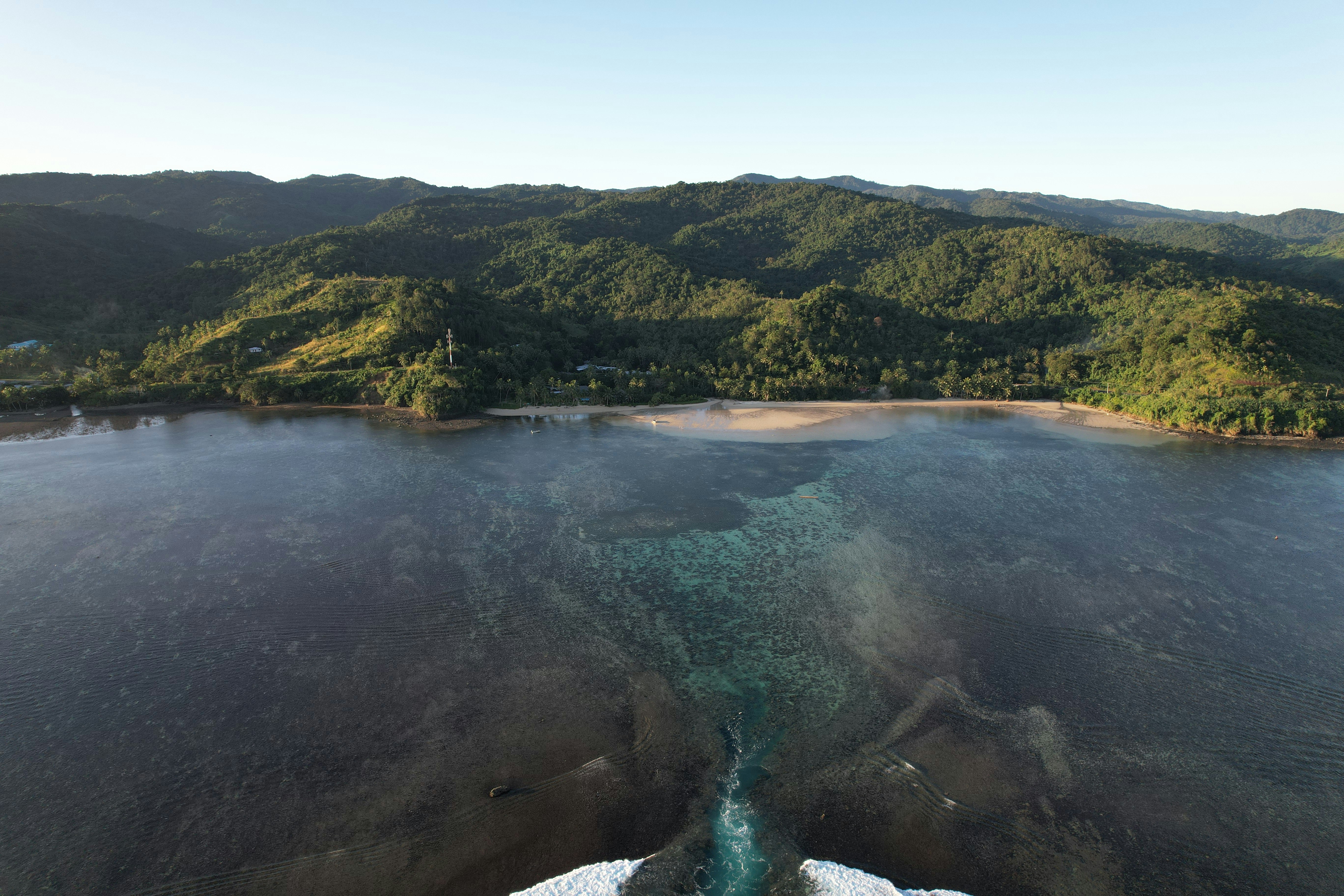 Emerald Bay Aerial: Coastal Cove Woven Between Green Hills