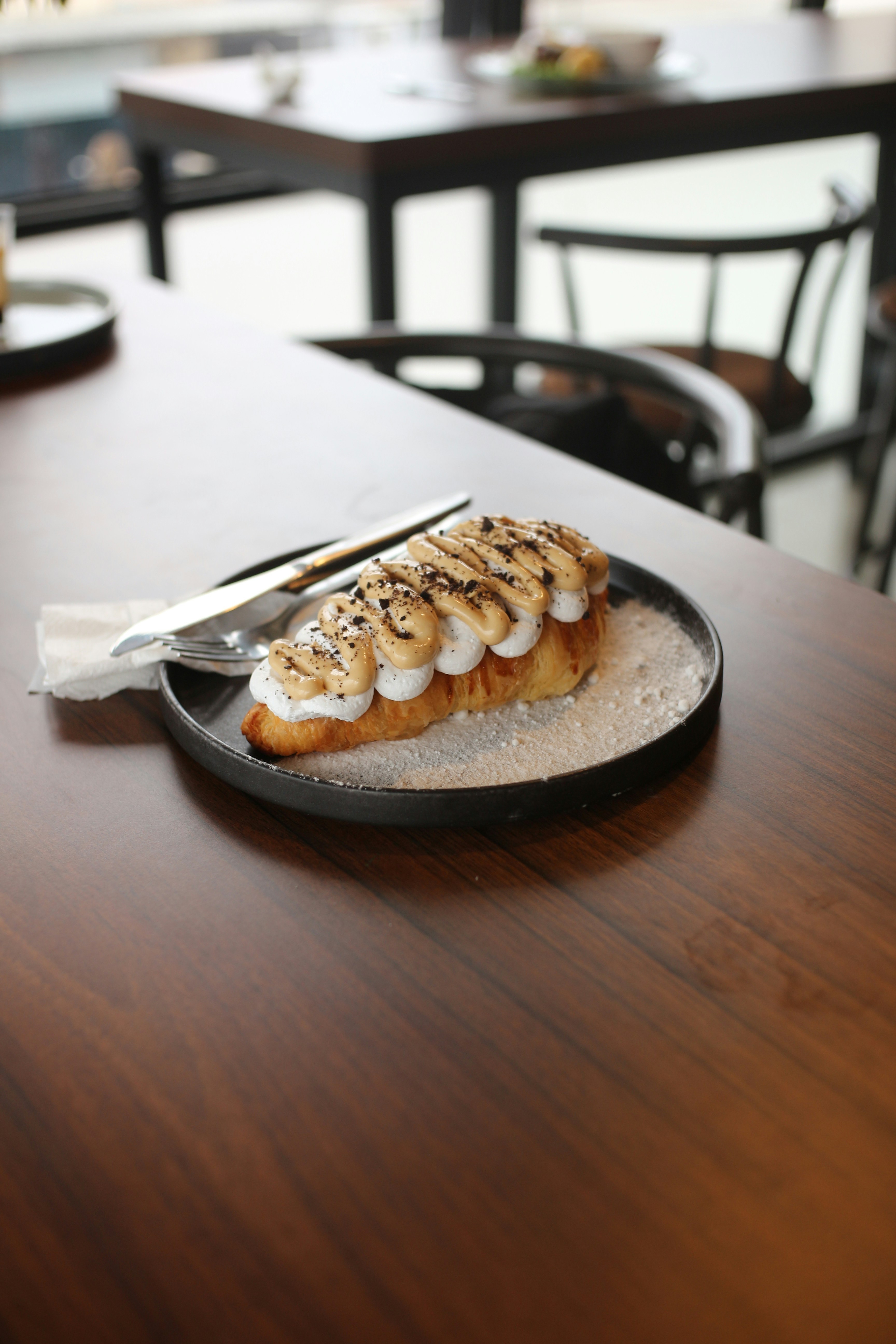 Banana-saffron pastry on a minimalist café table