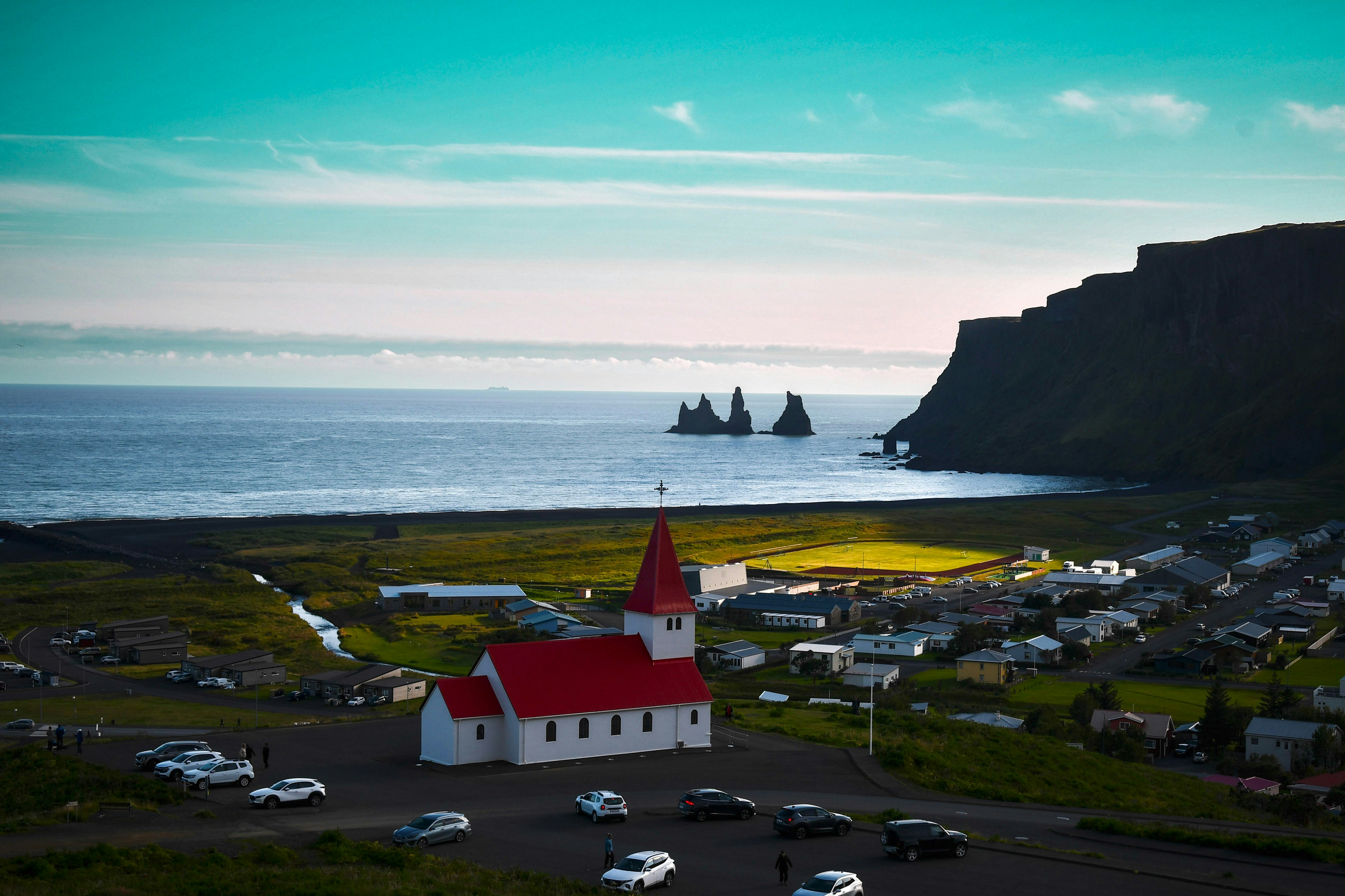 Coastal Church with Red Roof Under a Blue Sky