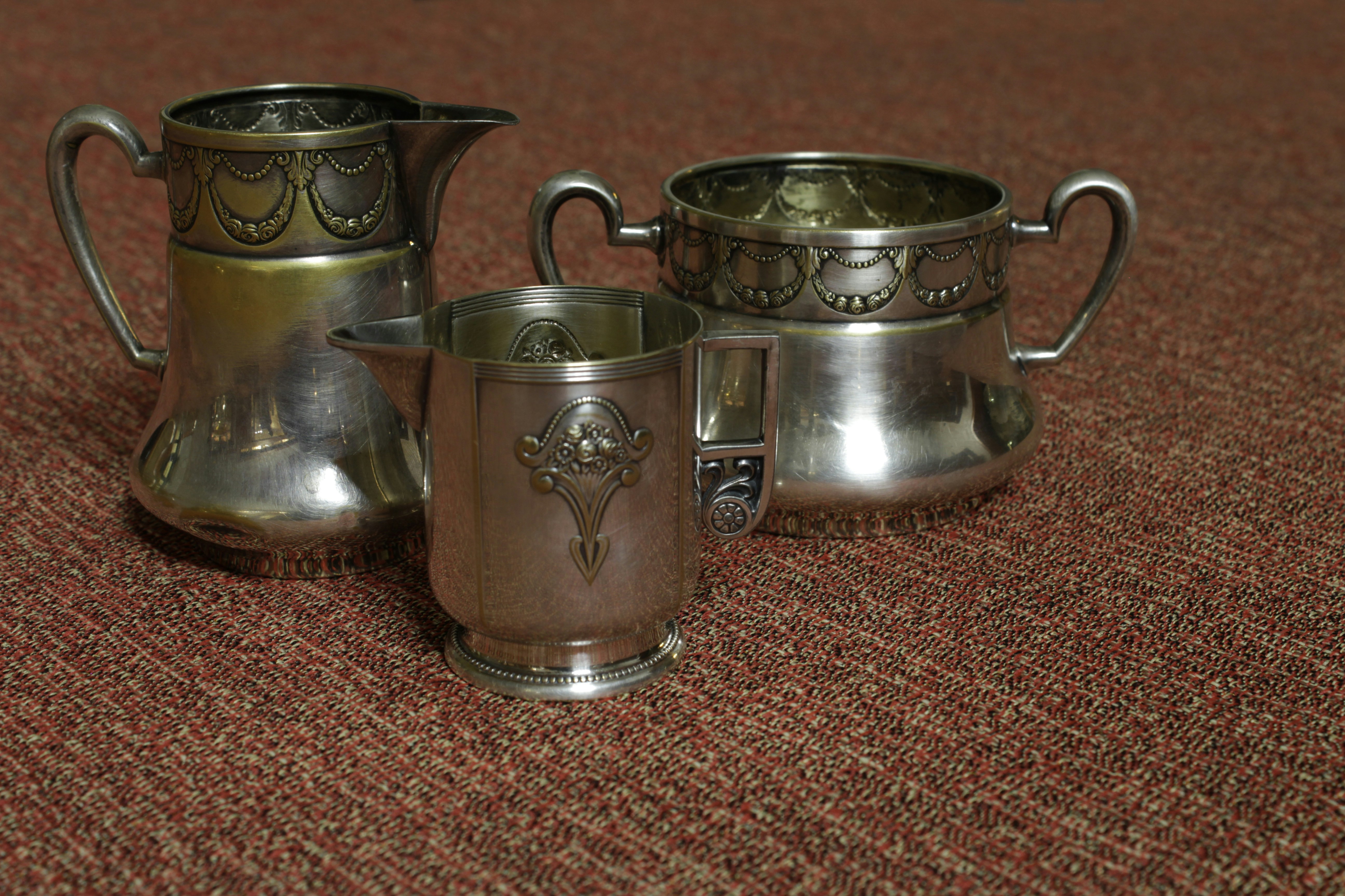 Heritage on a Tread: Silver Cups Resting on a Russet Carpet