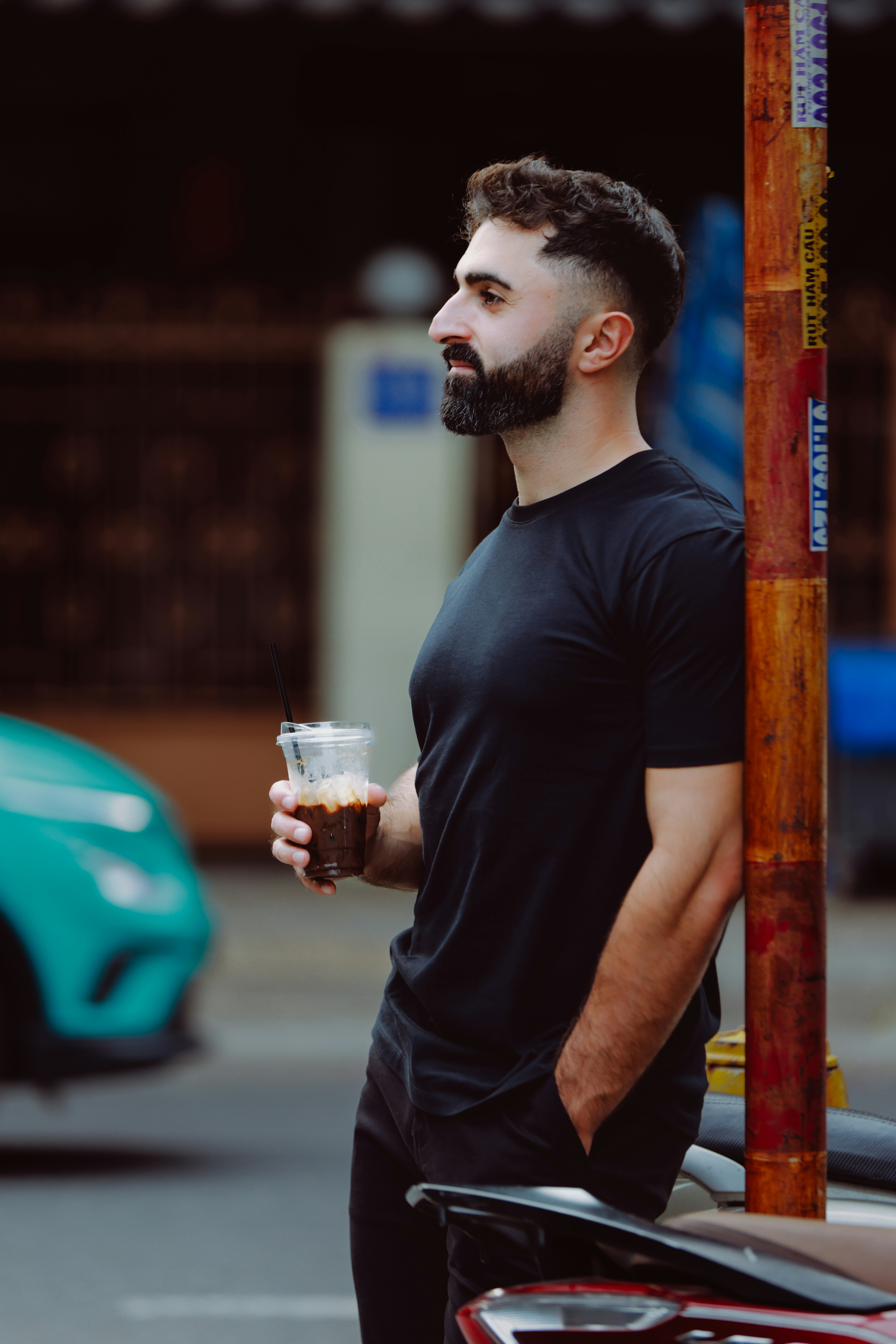 Side-Profile Calm: A Quiet Moment with Cold Brew by the Street