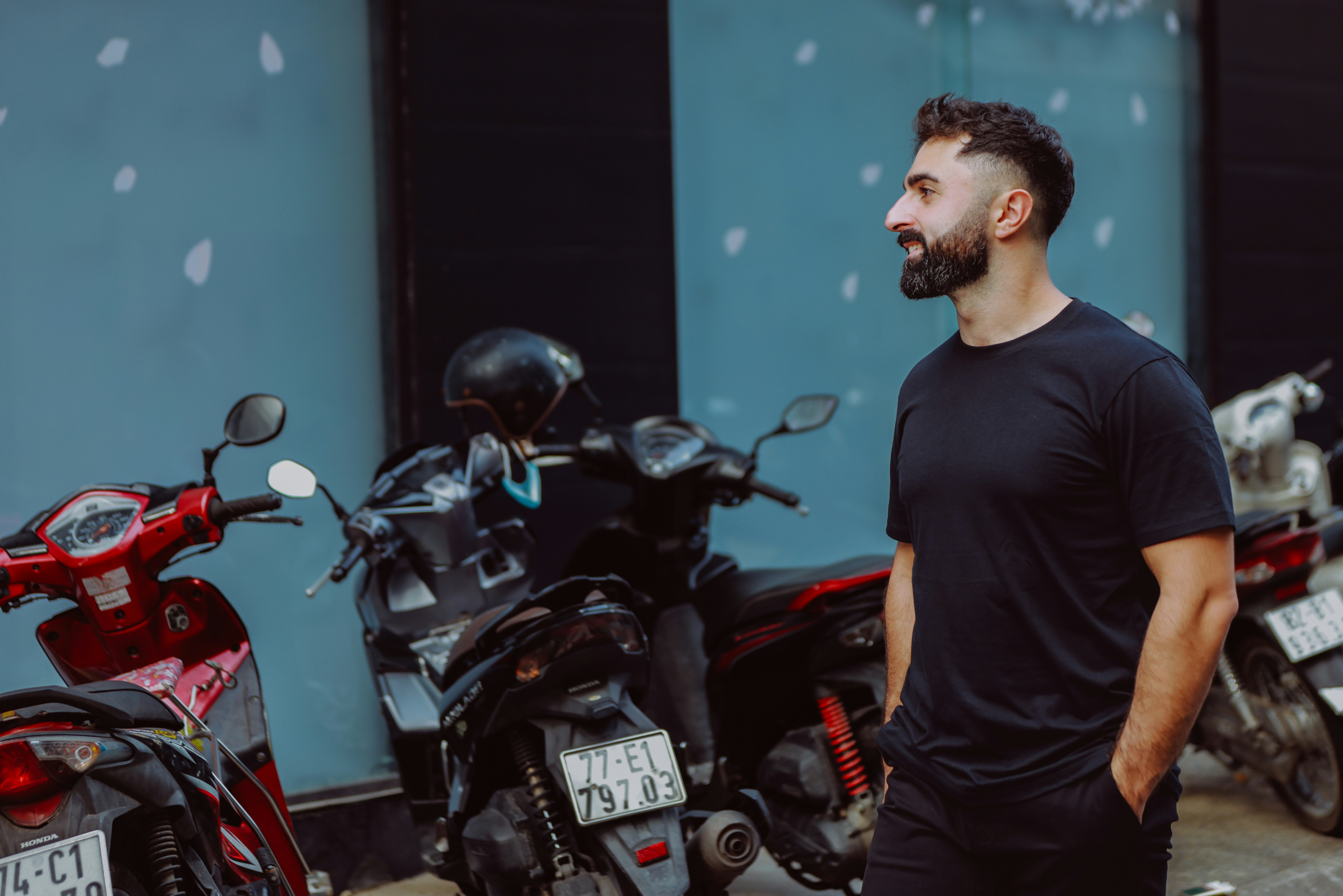 Portrait in a Quiet Alley: A Man with a Contemplative Stance among Motorcycles