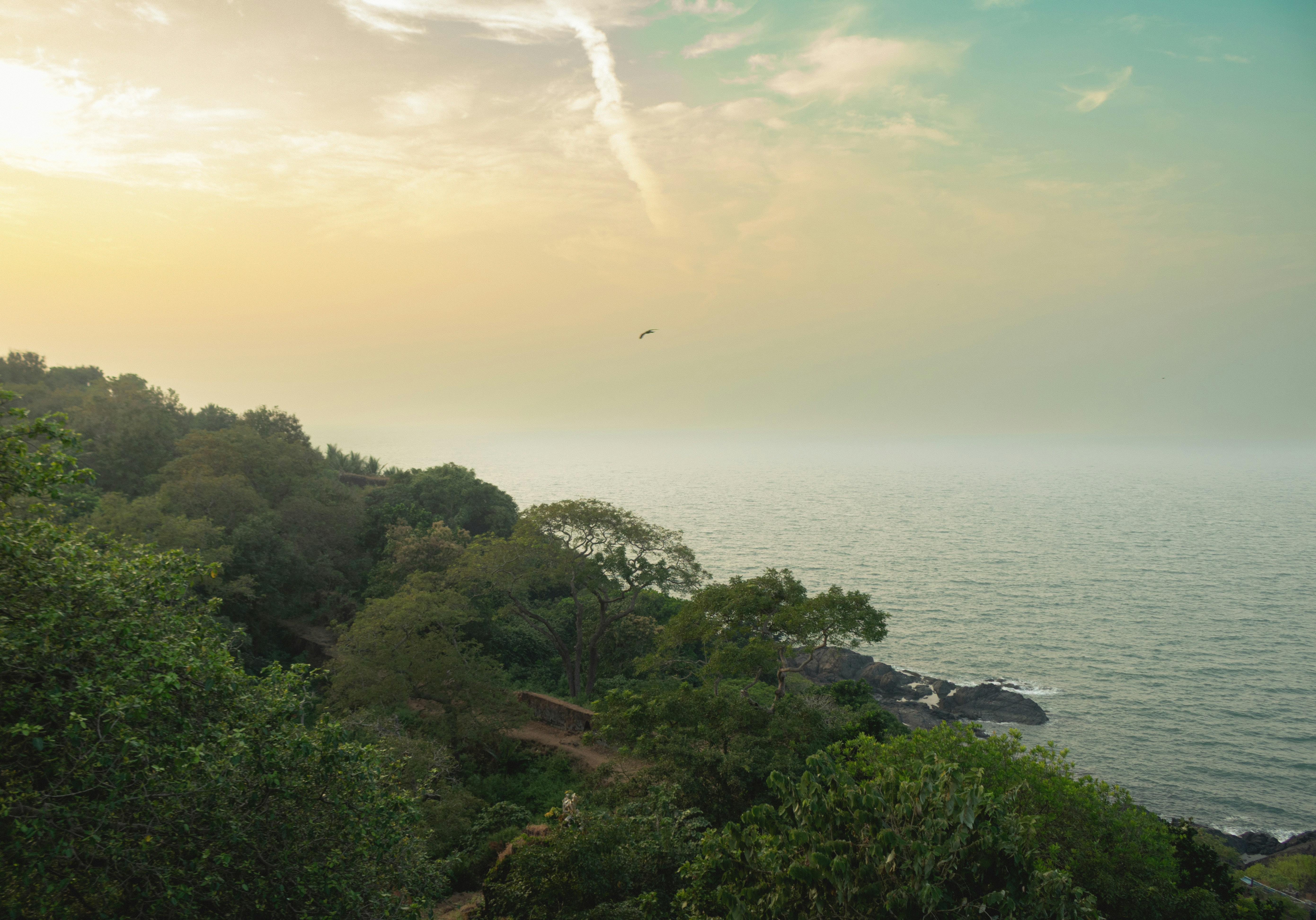 Sunlit Cliffs Over a Quiet Sea at Dusk
