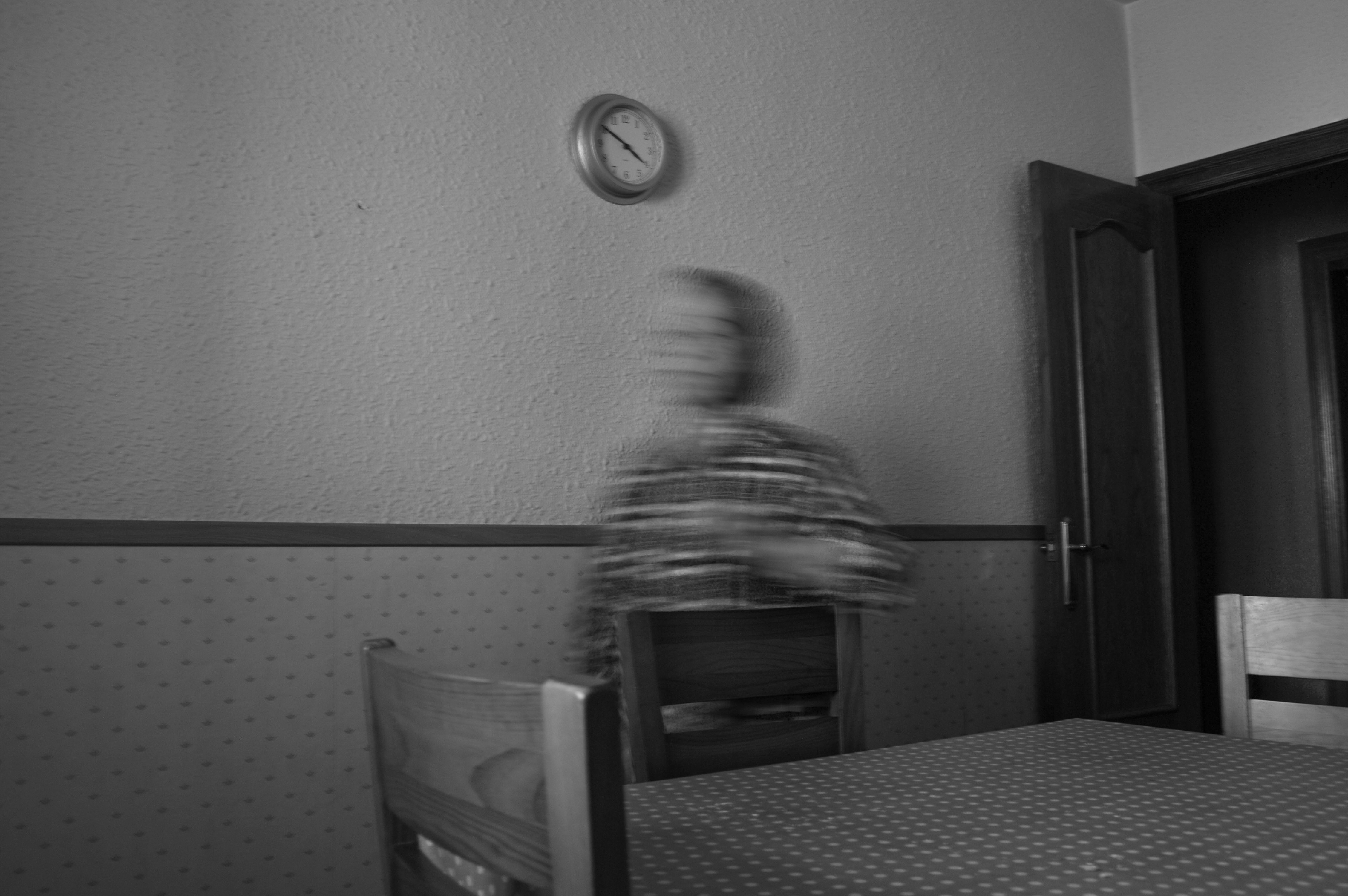 Blurred Visitor in a Quiet Kitchen