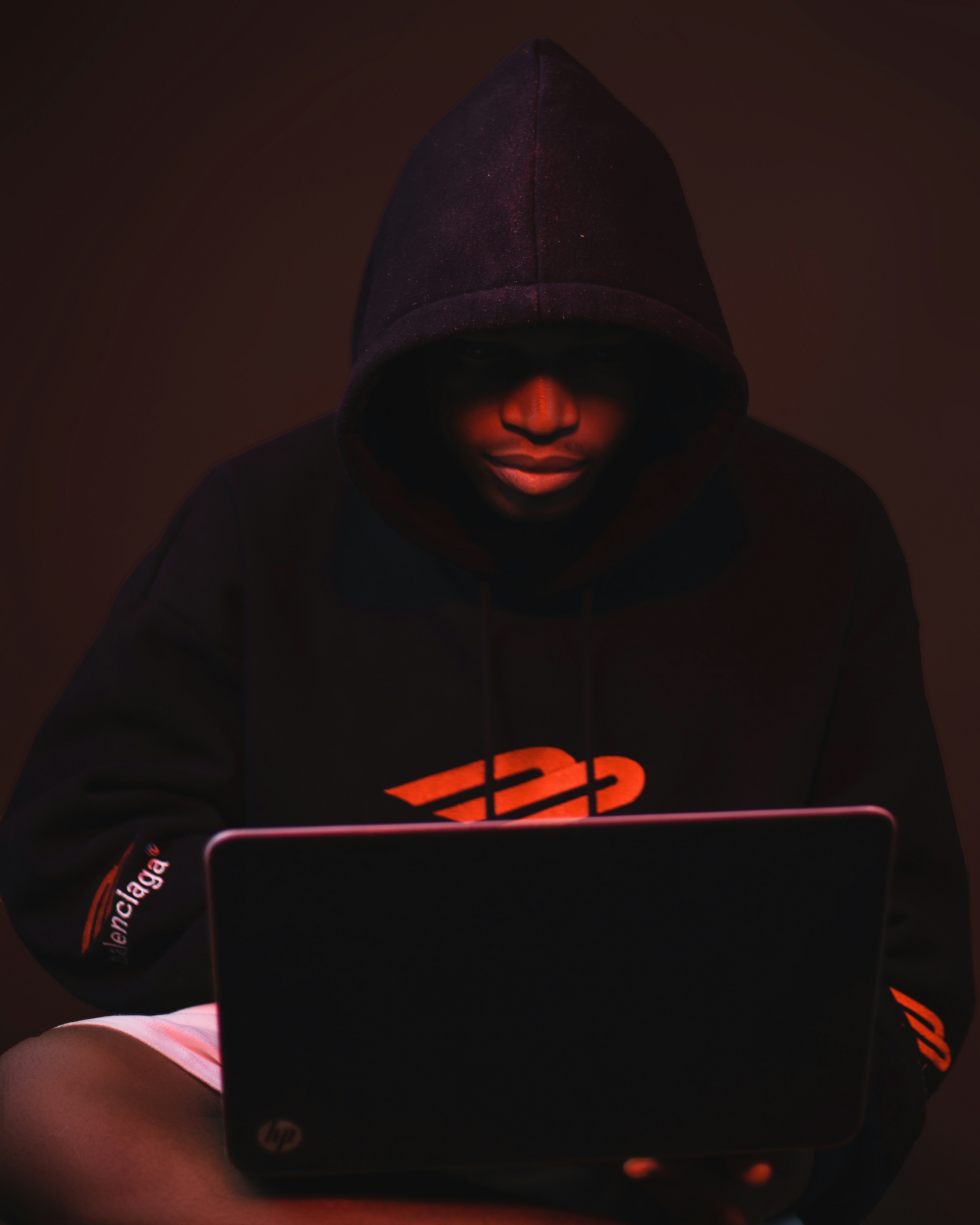 Shrouded Coder in the Dim Glow of Night, Laptop Alight
